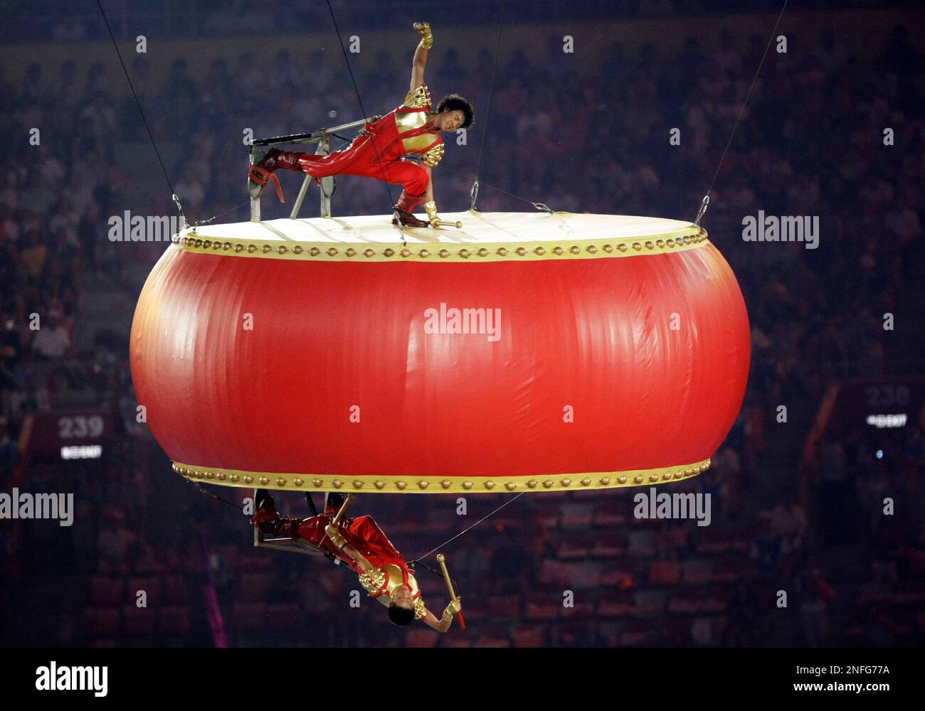 Drummers float above the crowd during the closing ceremony for the ...