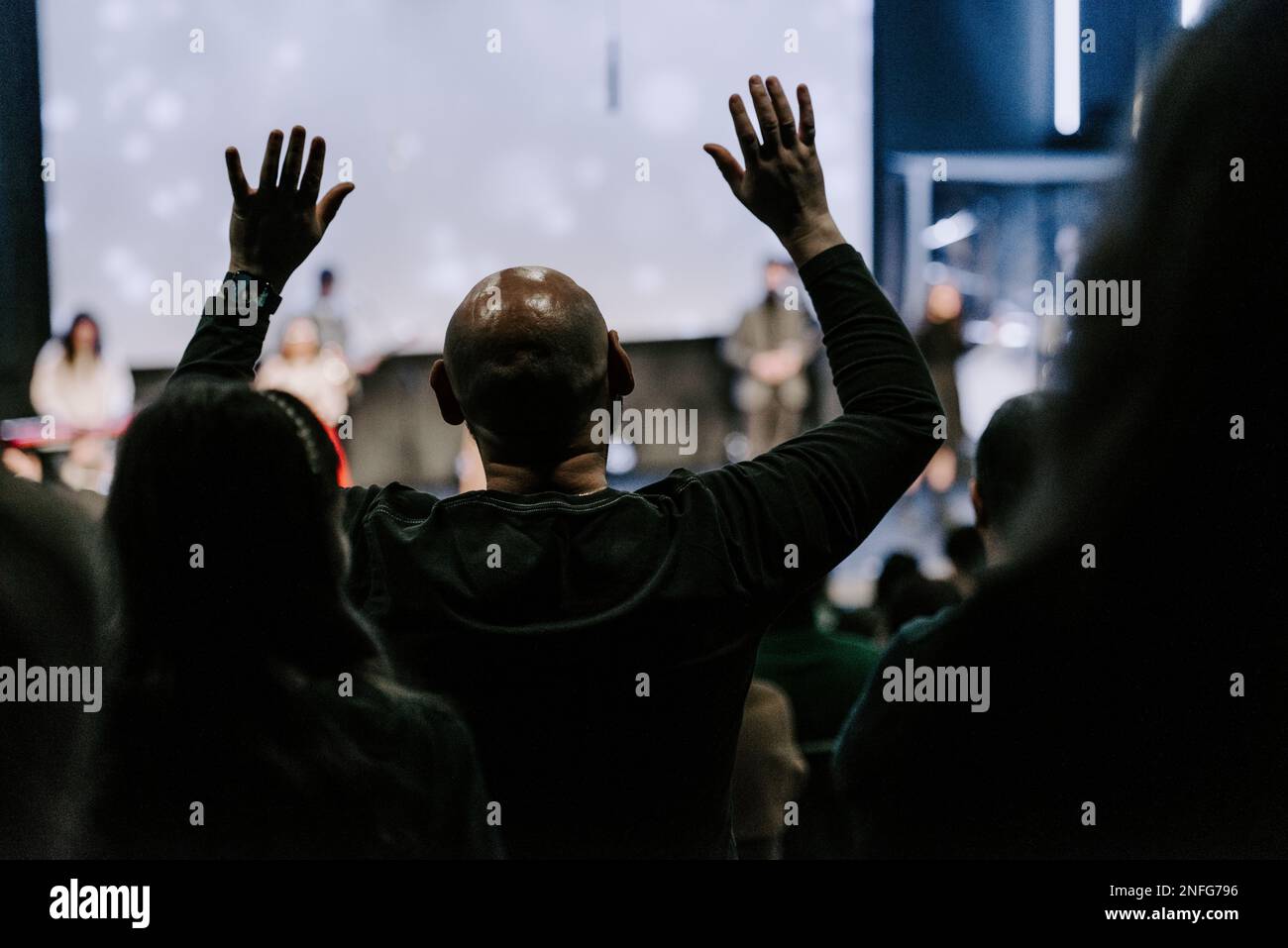 Hands in the air of people who praise God at church service Stock Photo ...