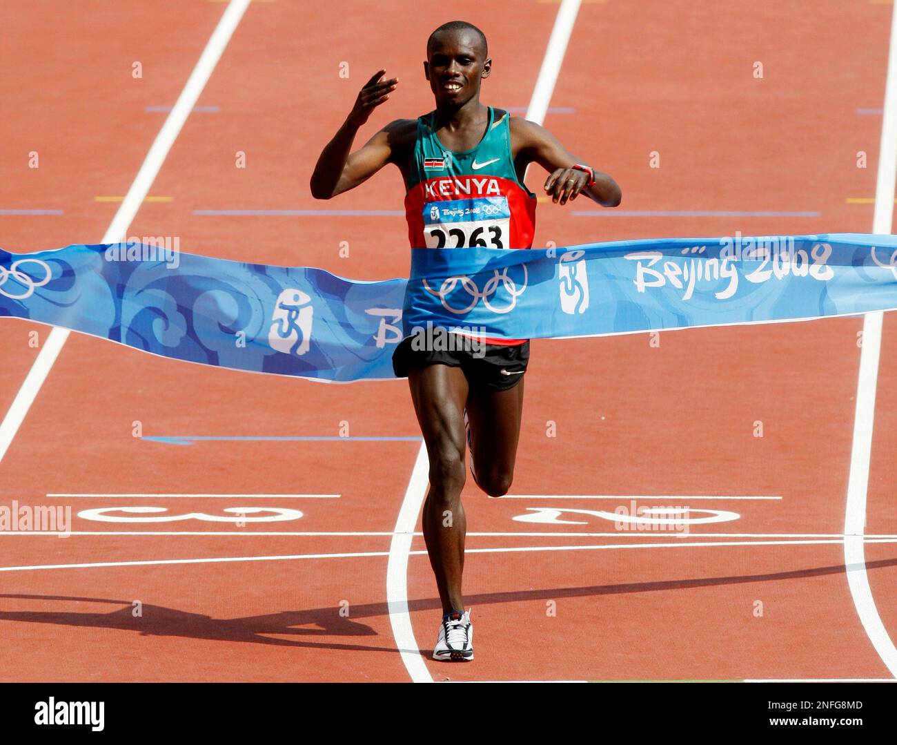 Kenya's Samuel Kamau Wanjiru crosses the finish line to win the men's ...