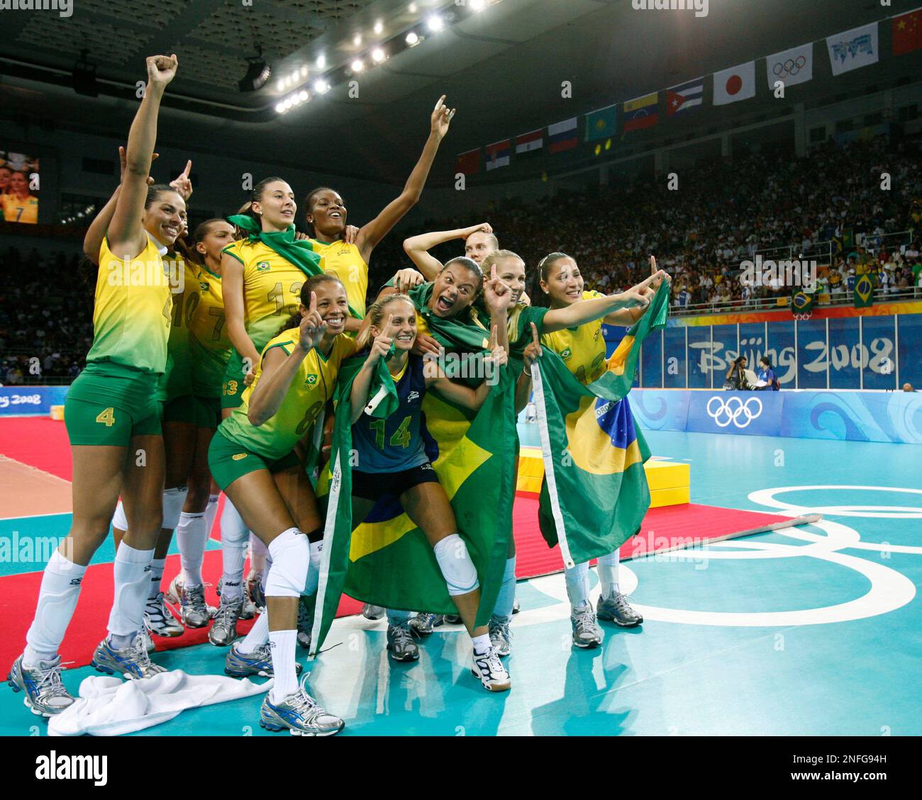 Brazil volleyball players celebrate with their national flag after ...