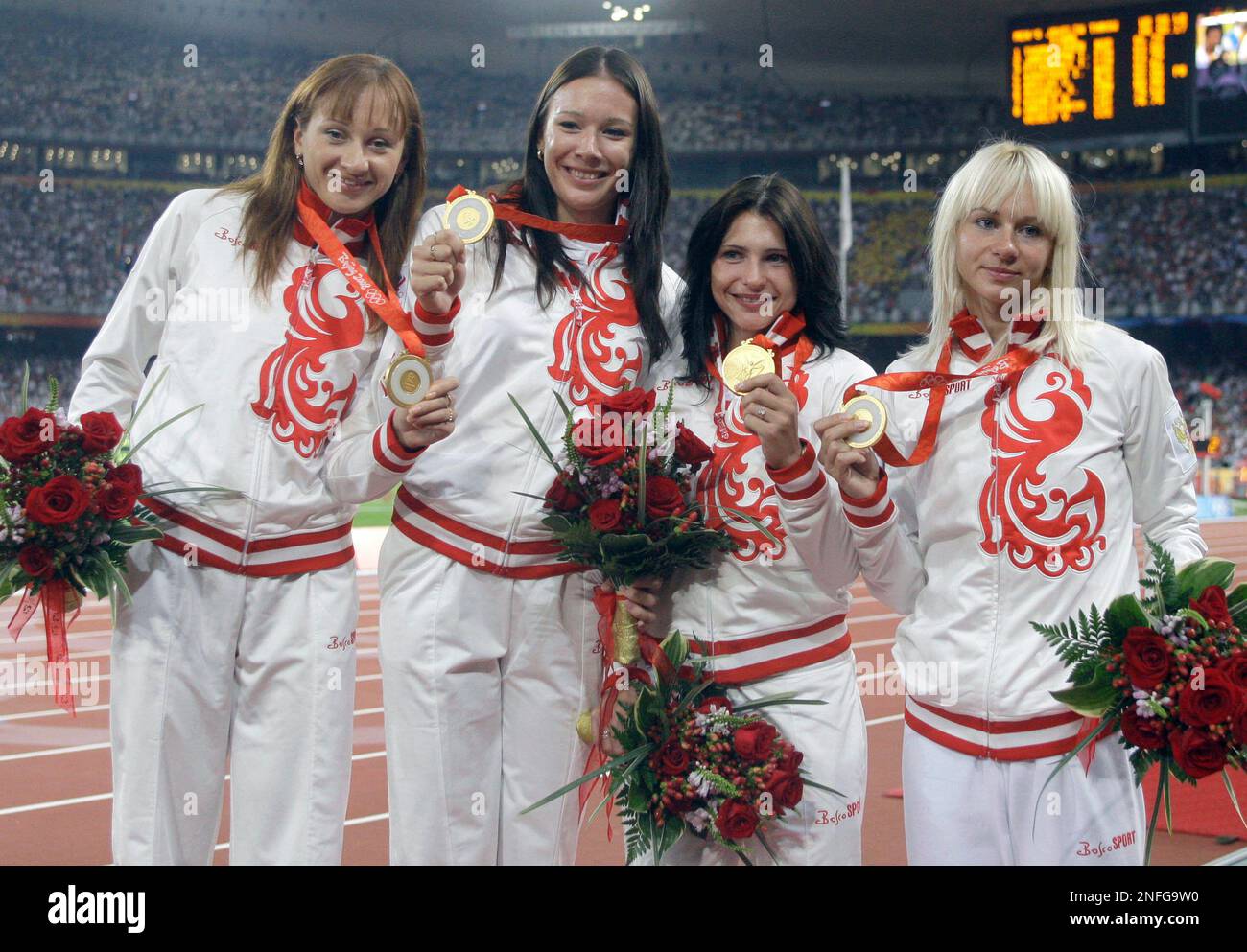 Russian gold medalists from the women's 4x100-meter relay team smile ...