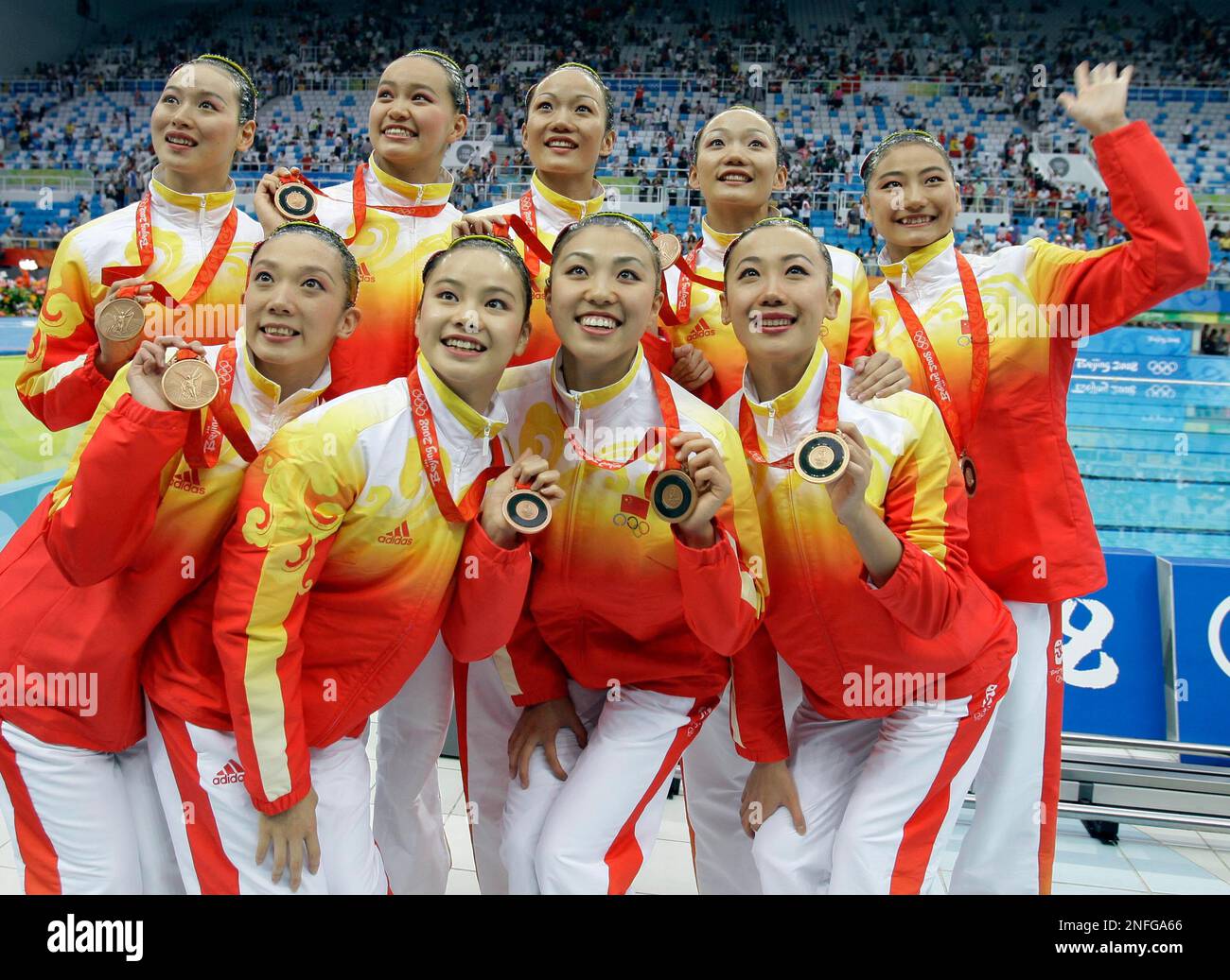 The Chinese synchronized swimming team poses with their bronze medals ...