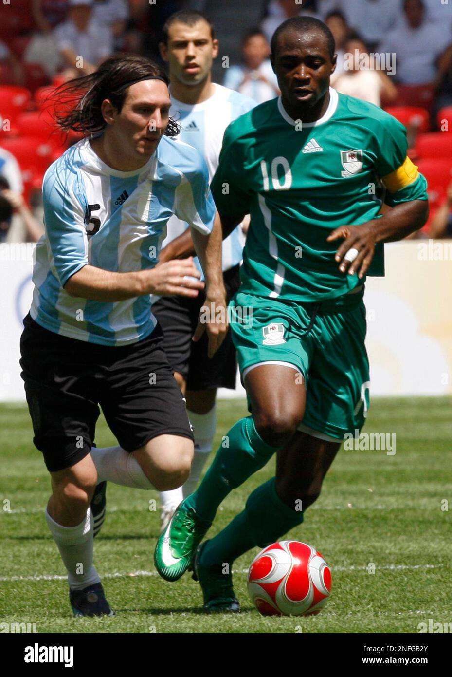 Argentina's Lionel Messi, left, is chalenged by Nigeria's Promise Isaac ...