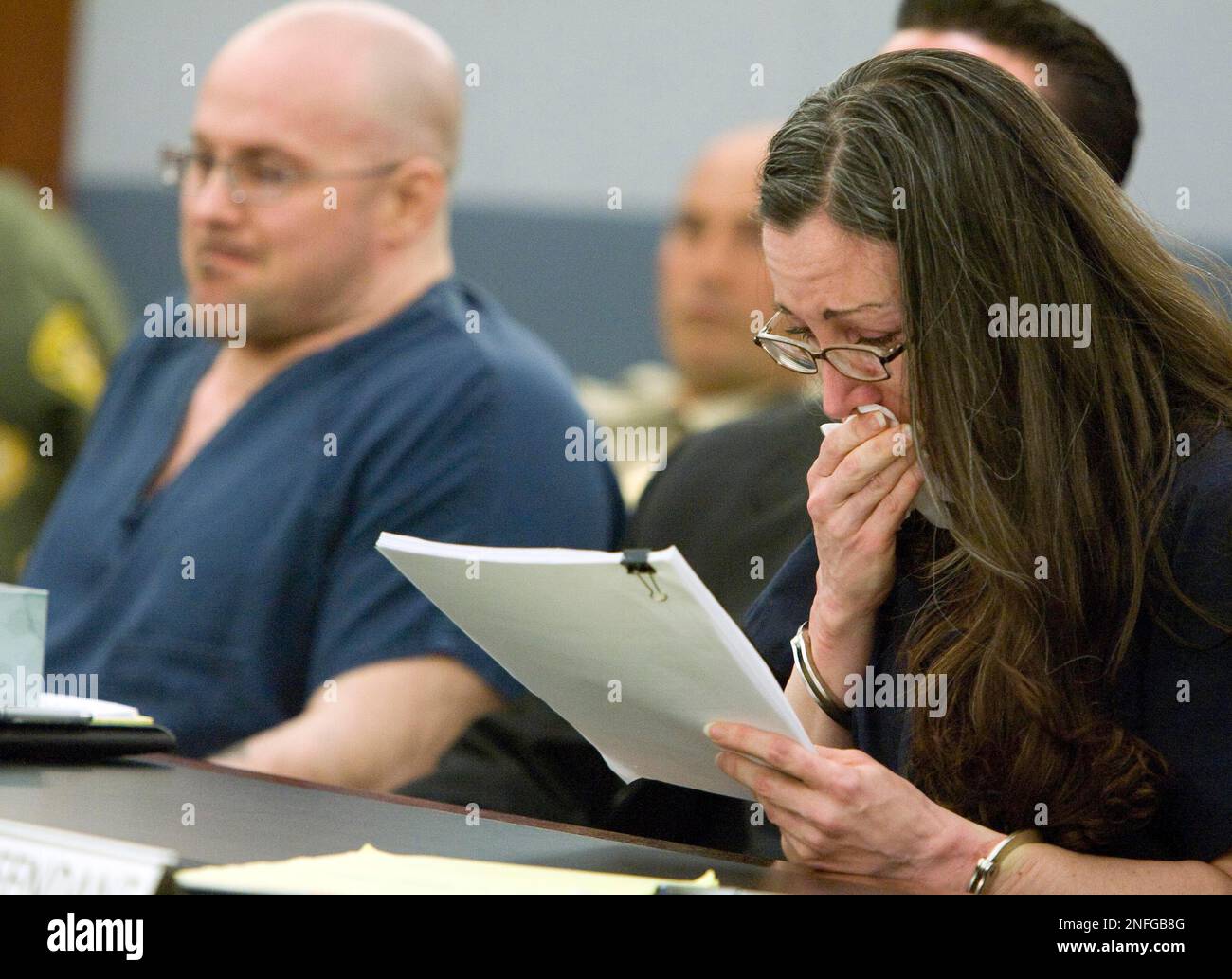 Professional bodybuilder Kelly Ryan, right, reads a statement to the ...