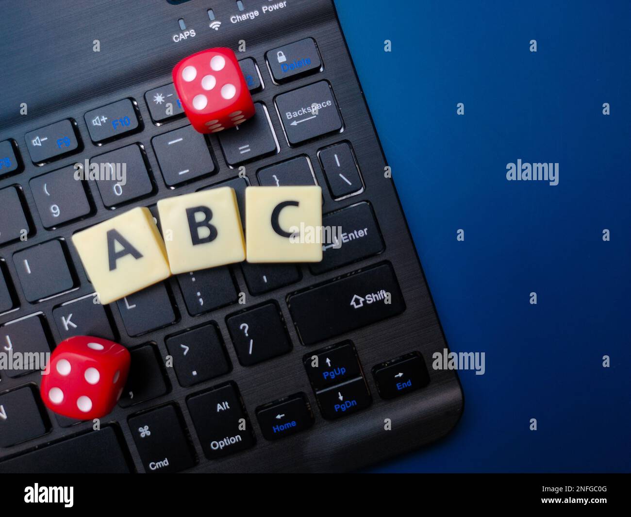 Black keyboard,red dice and toys word with the word ABC on blue ...