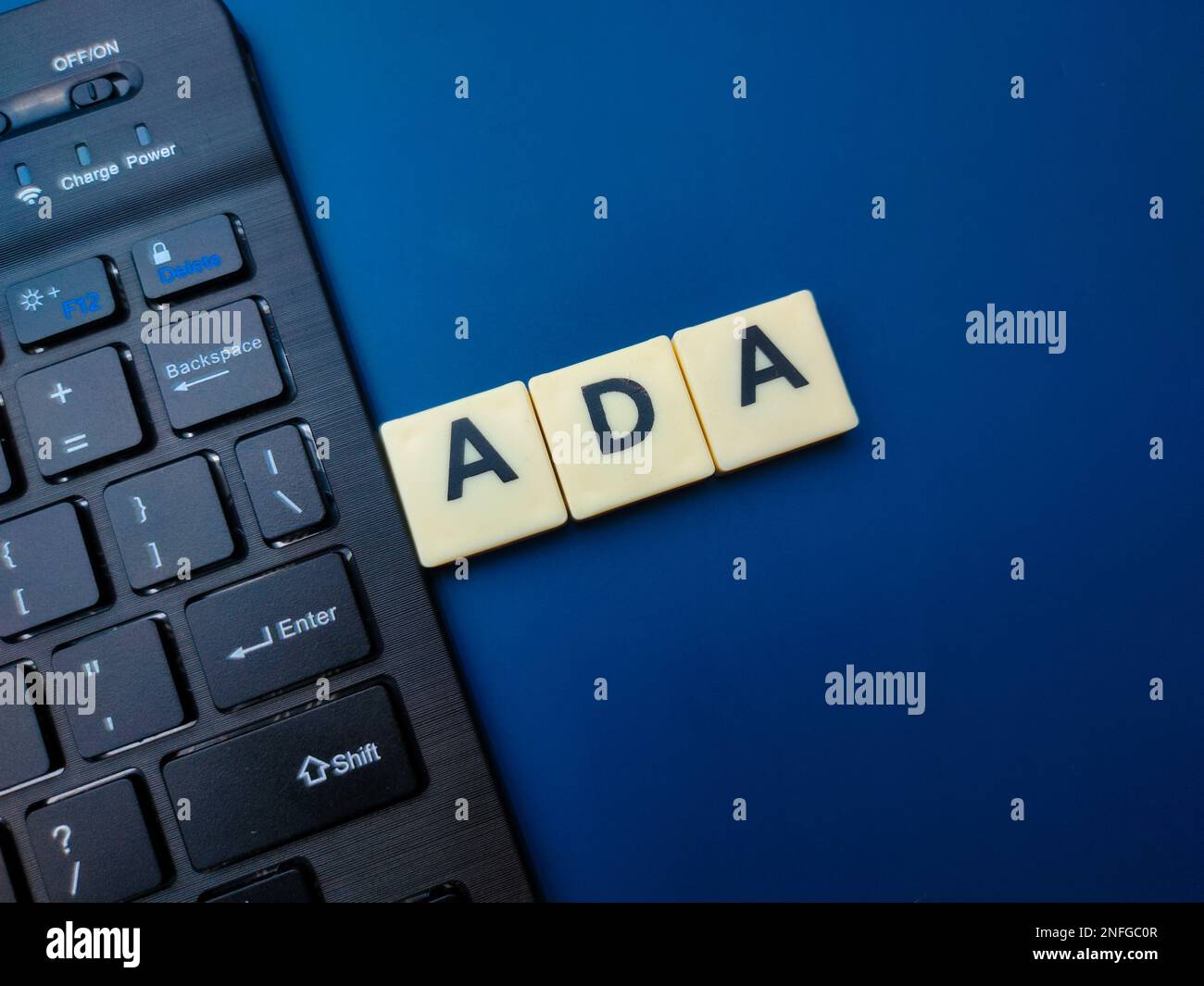 Toys word and keyboard with the word ADA on blue background. Business ...