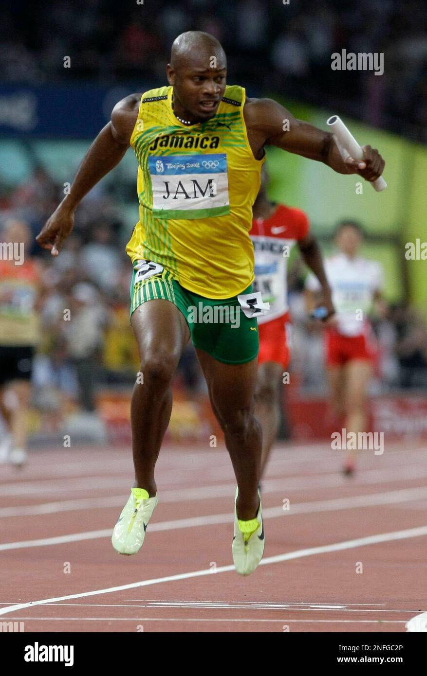 Jamaica's Asafa Powell crosses the finish line to win the gold medal in ...