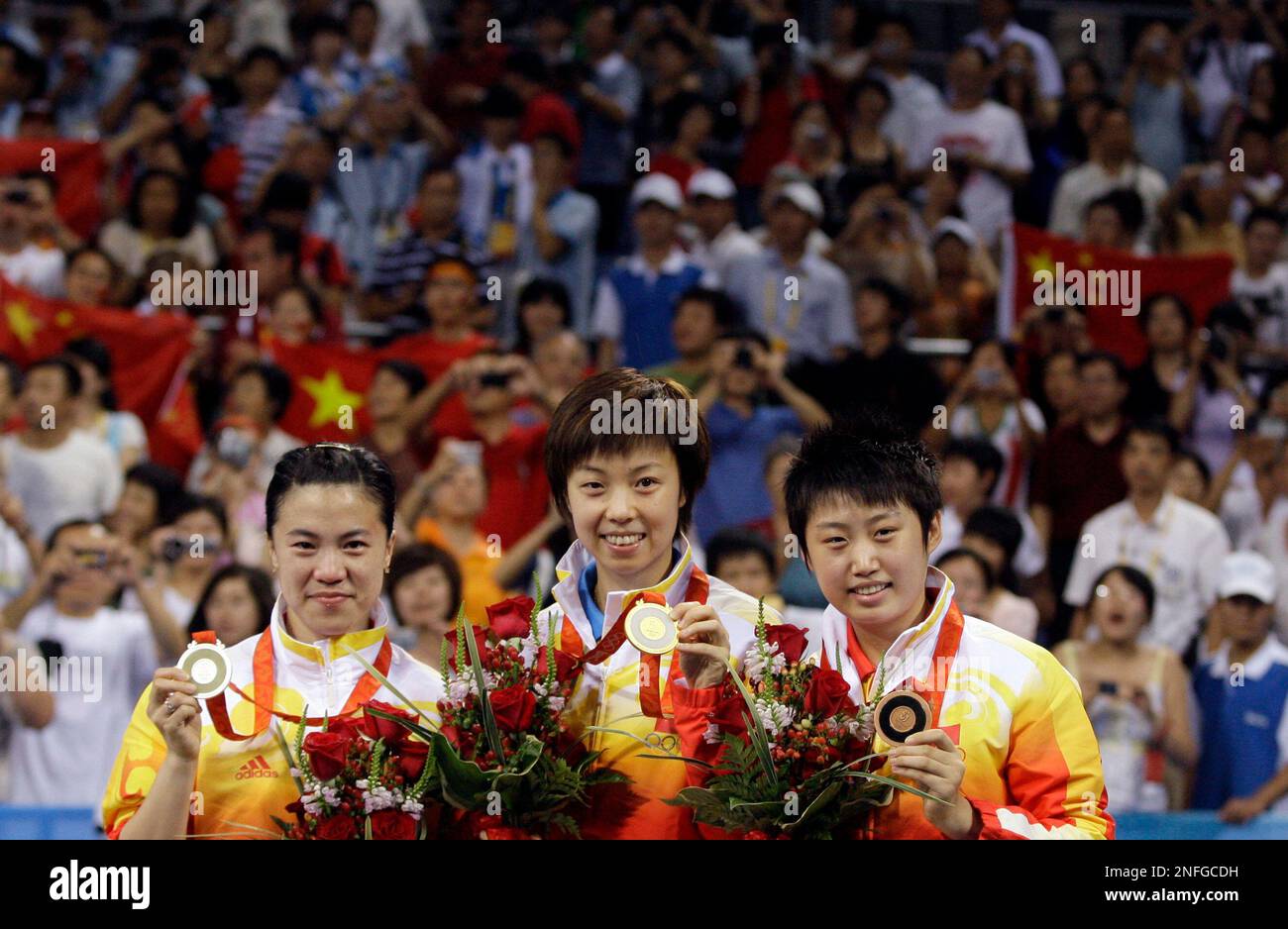 Gold medalst Zhang Yining, center, silver medalist Wang Nan, left, and ...