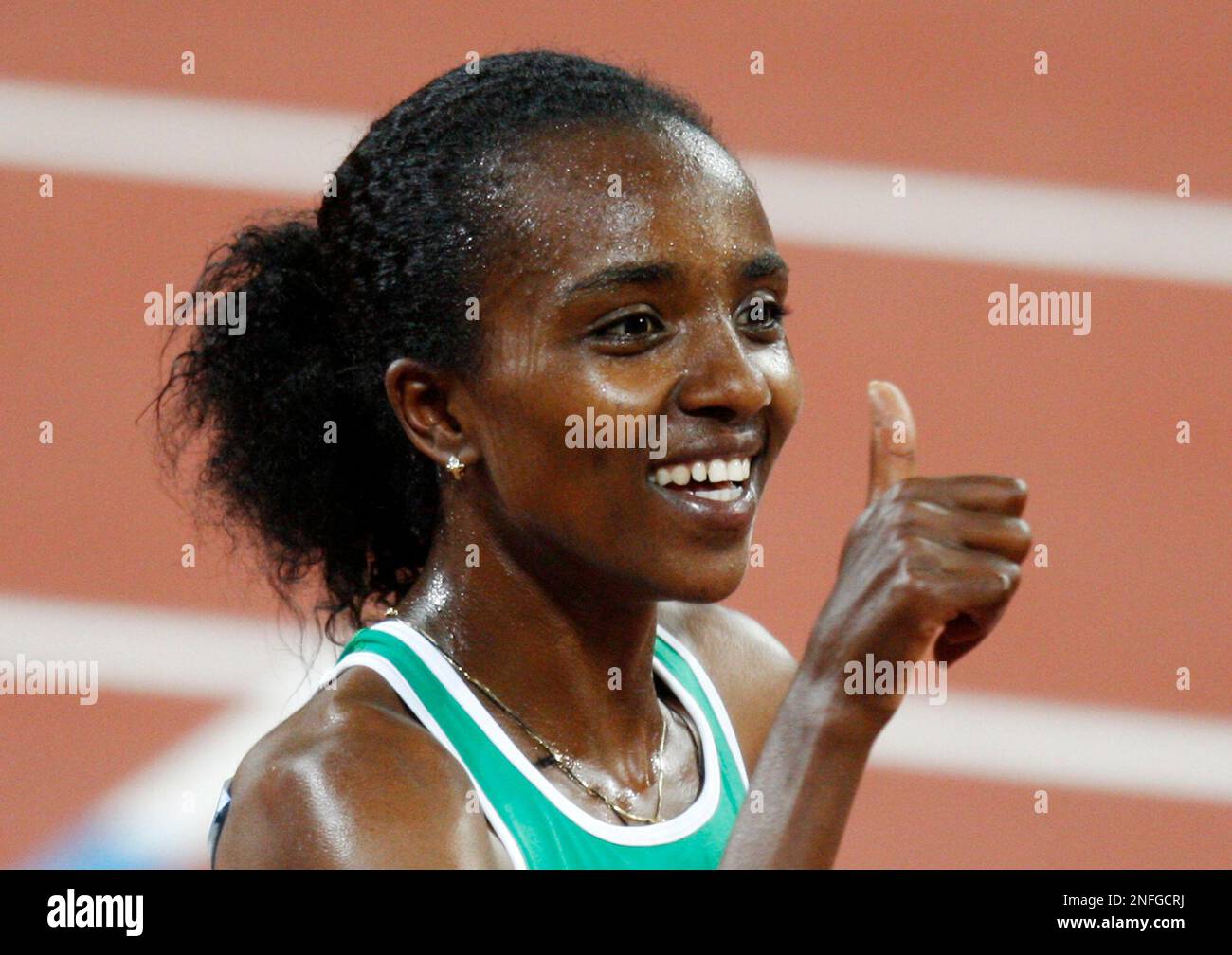 Ethiopia's Tirunesh Dibaba celebrates winning the gold in the women's ...