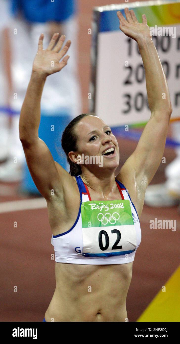 Heather Fell of Great Britain celebrates as she crosses the finish line ...