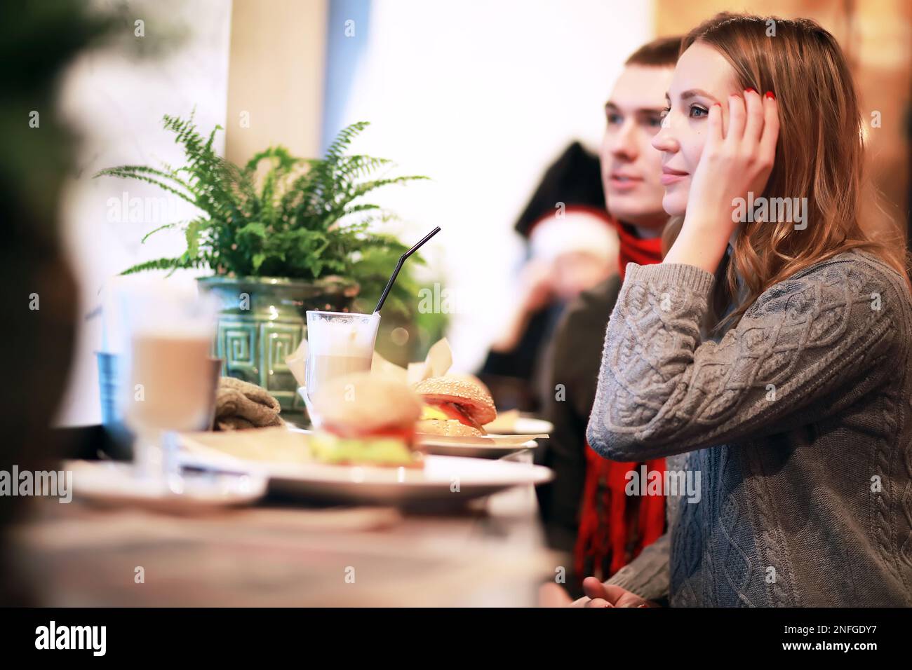 Happy couple eating fast food burger and doner in fast food cafe Stock ...