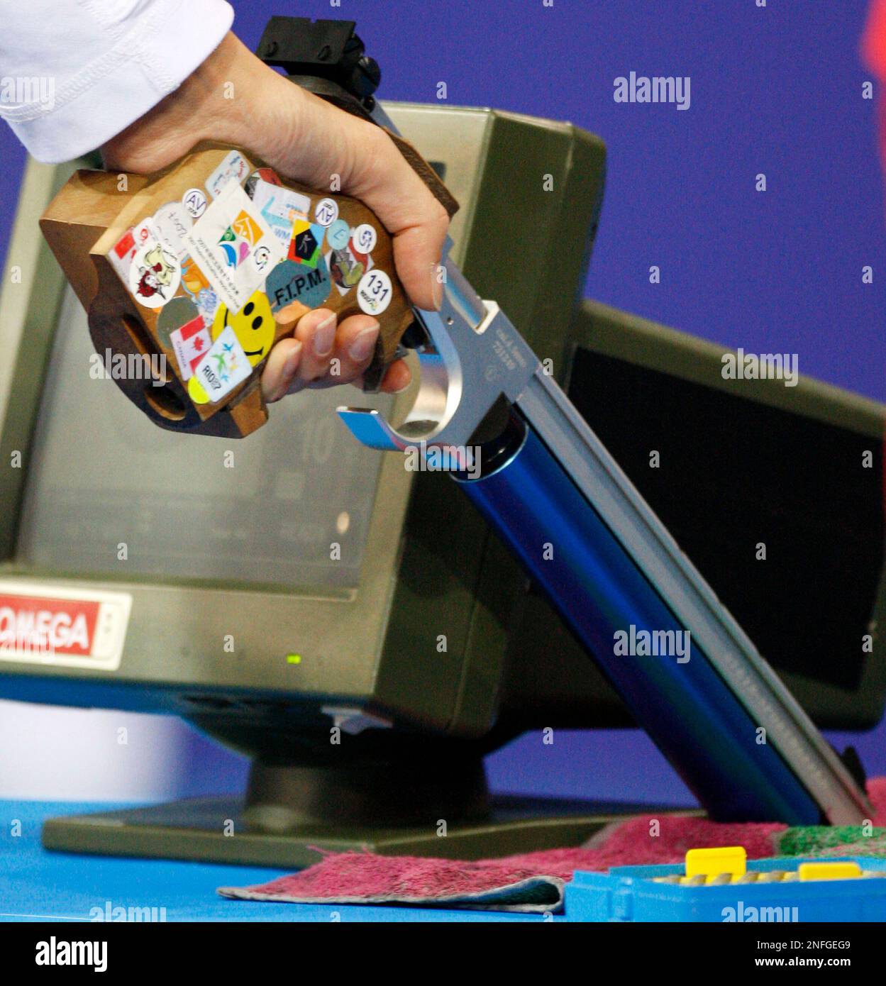 A contestant gets ready to use her pistol at the shooting event of ...