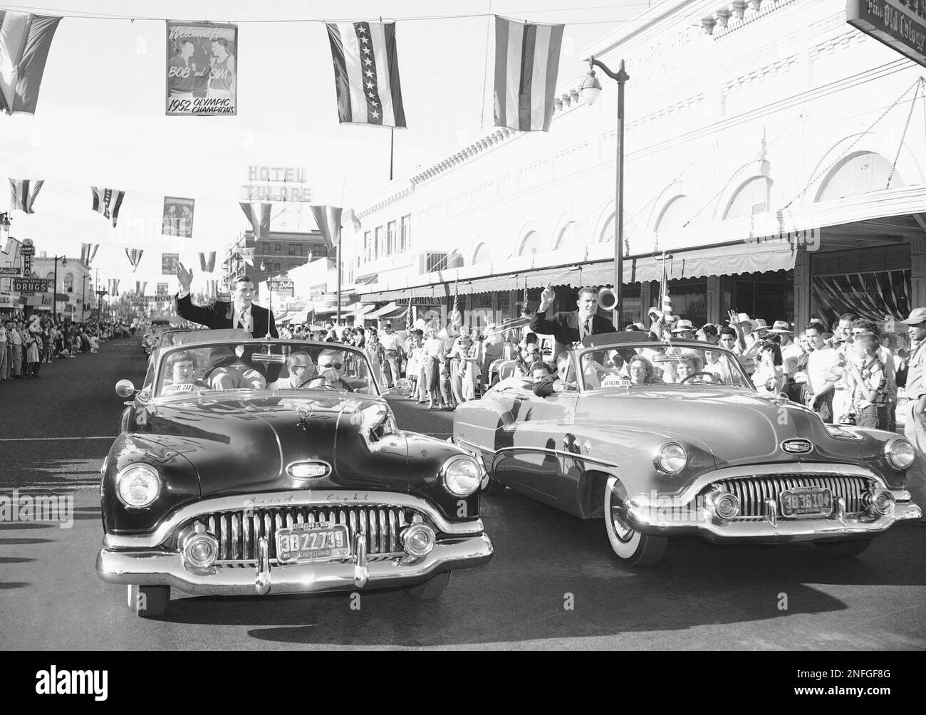 Bob Mathias, Olympic decathlon champion, left, and Sim Iness, discus champion of the Olympic ...
