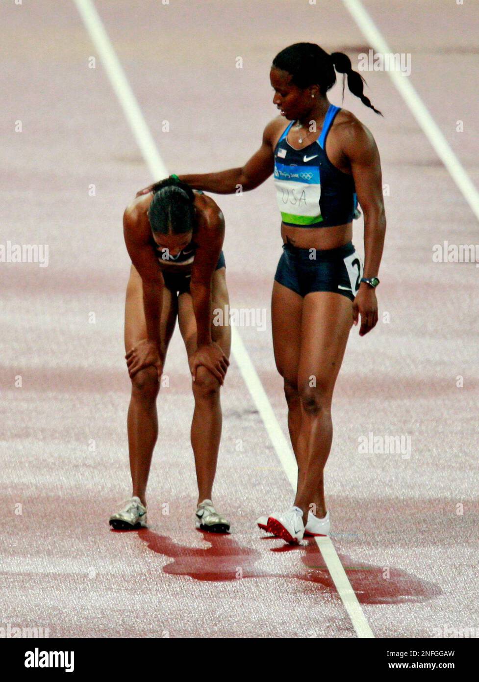 United States' Torri Edwards, left, is consoled by her teammate ...