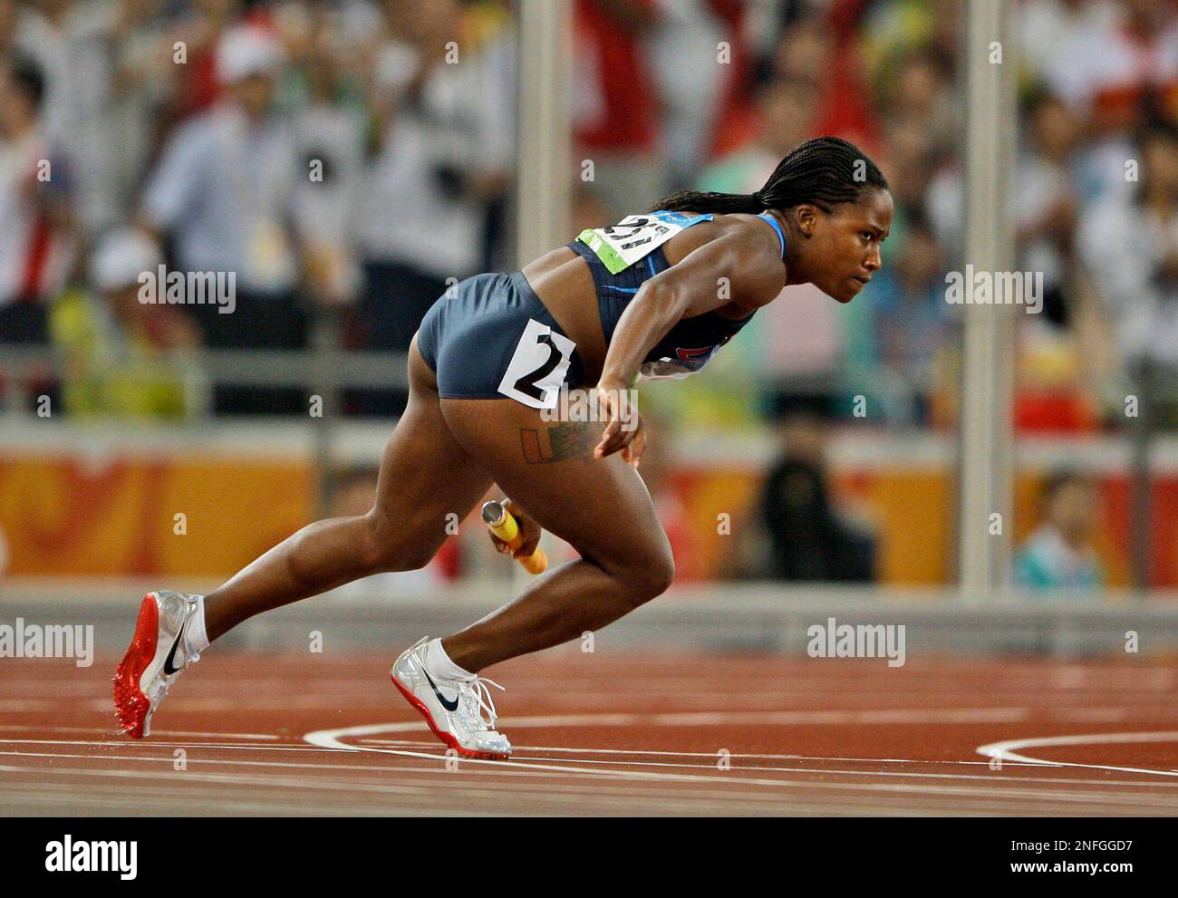 United States' Lauryin Williams grabs the dropped baton in a women's ...