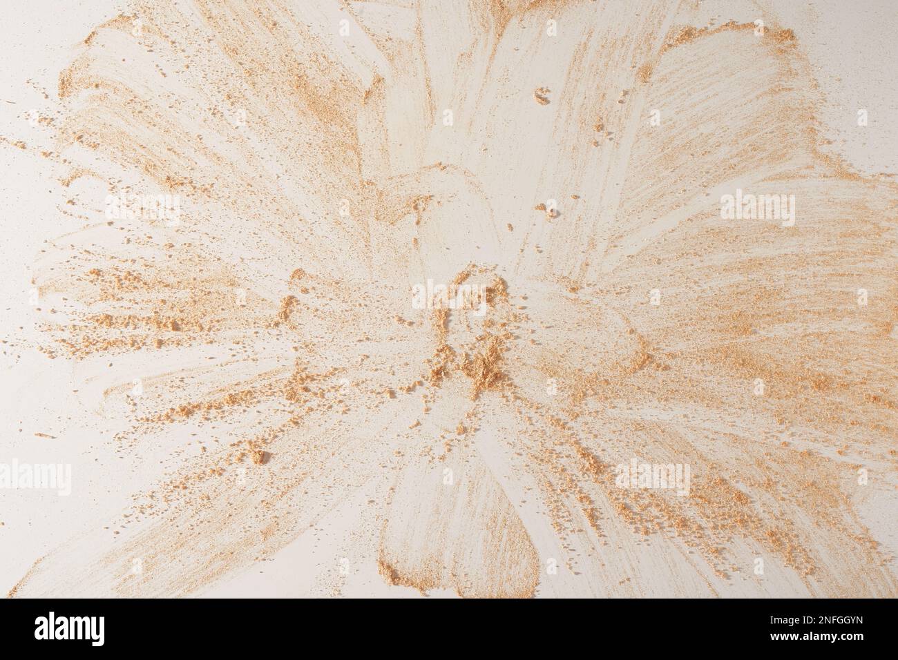 A neutral-colored face powder smeared on the surface, on a light ...