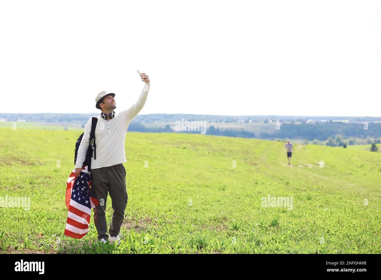 Man waving American flag standing in farm agricultural field , holidays ...
