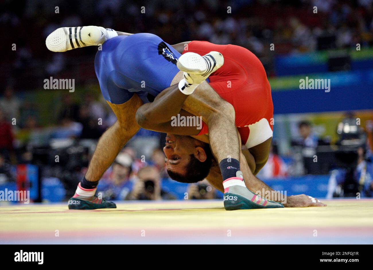 Otar Tushishvili of Georgia in blue, wrestles against Geandry Garzon of ...