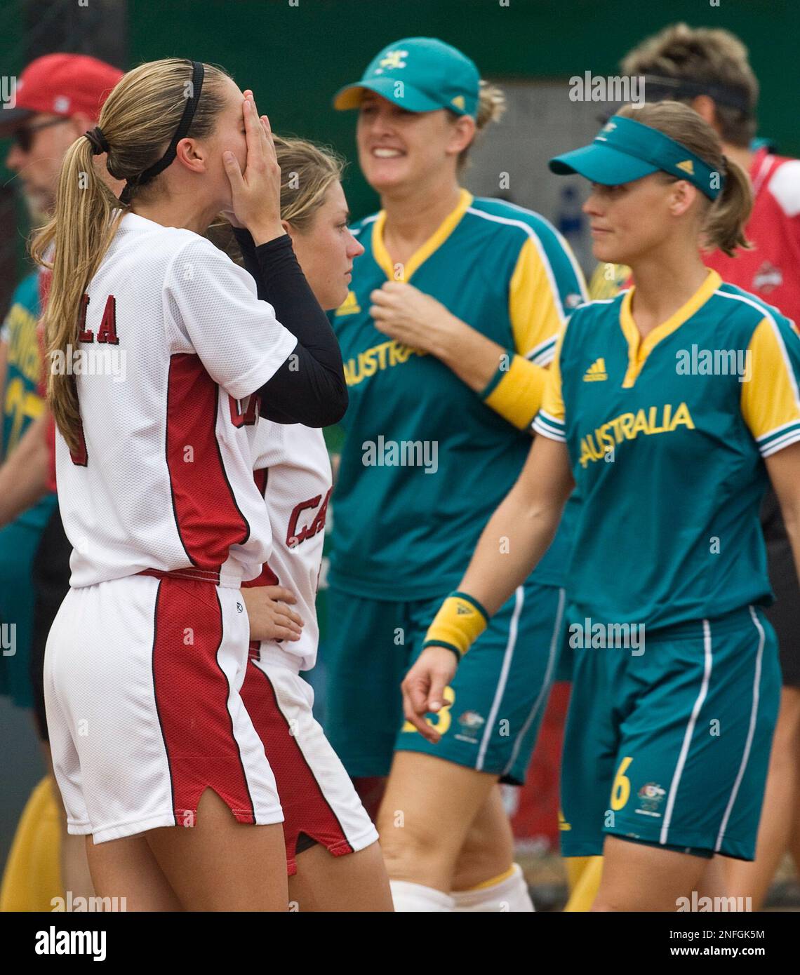 Canada's pitcher Lauren Bay Regula walks past Australia's Kelly Hardie ...