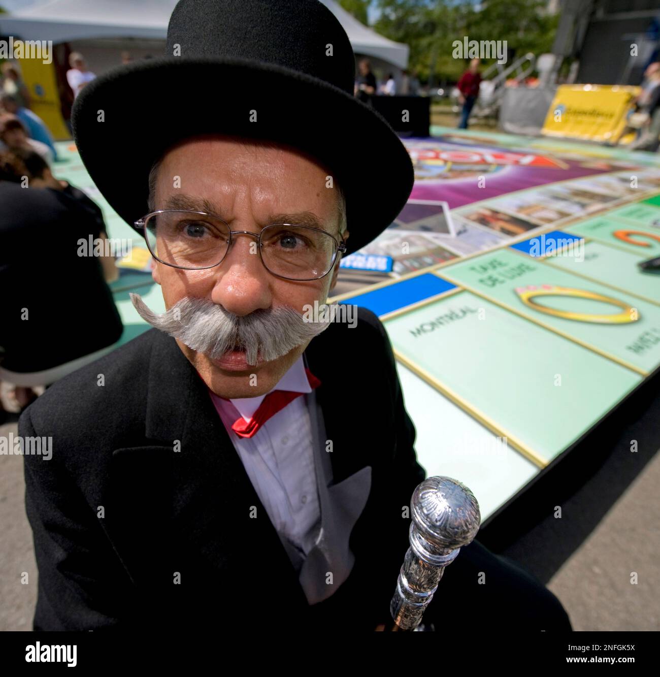 Mr. Monopoly sits by the city of Montreal space on a giant Monopoly ...