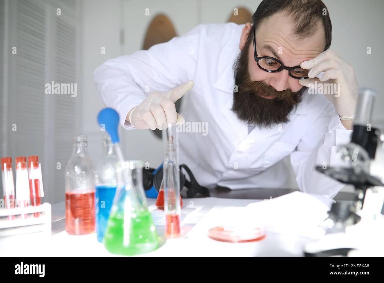 Chemist crazy. A mad scientist conducts experiments in scientific ...