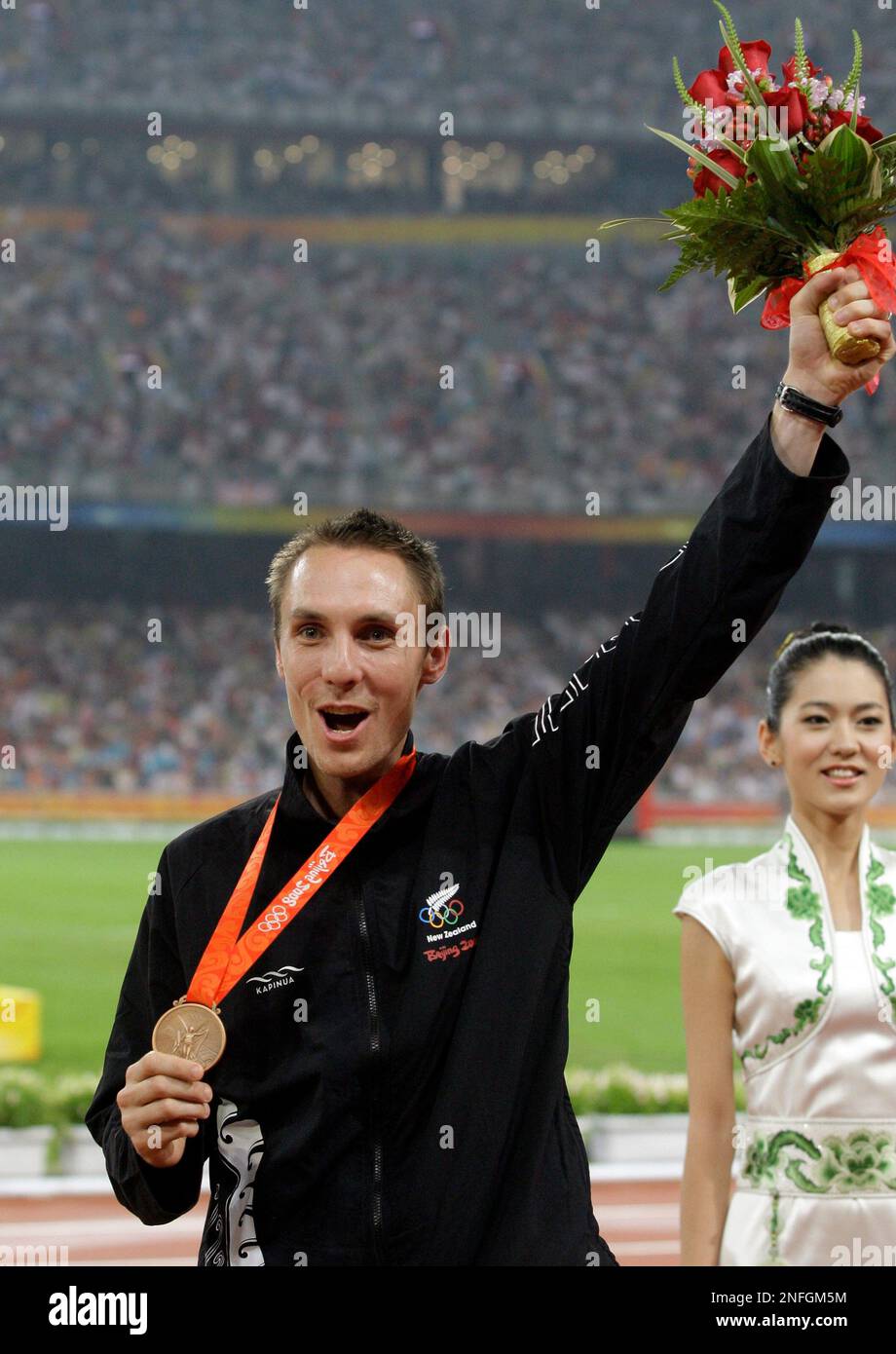 Men's 1,500-meter bronze medalist Nicholas Willis of New Zealand waves with his medal during the ...
