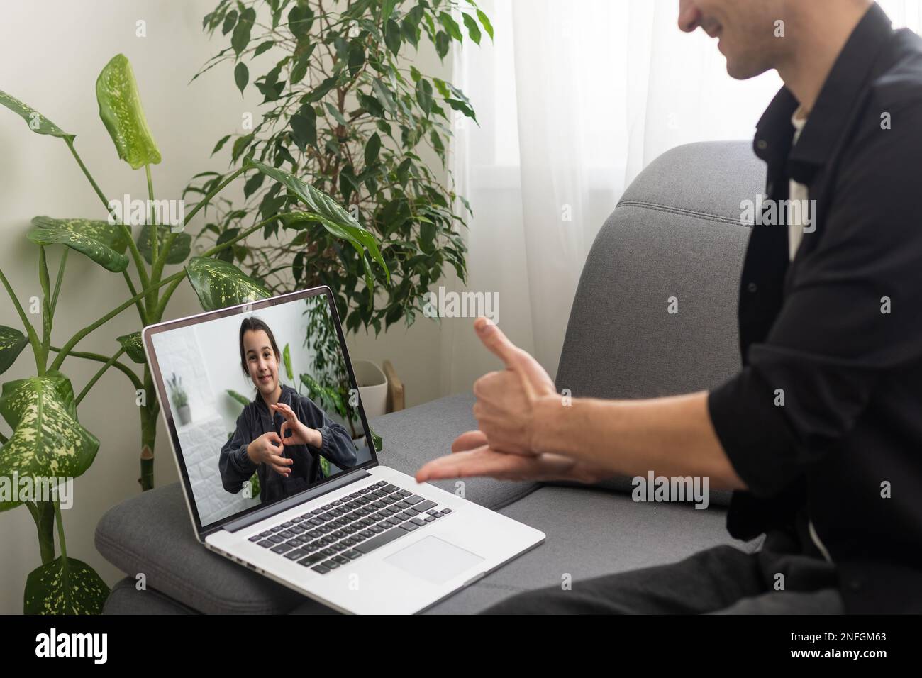 Happy smiling deaf young caucasian man uses sign language while video ...