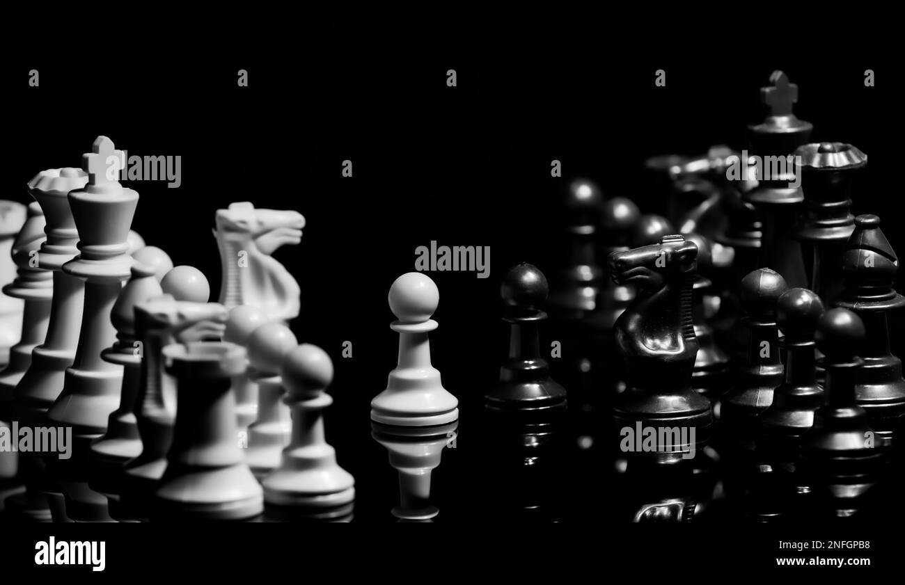 Close up of Chess pieces on a reflective mirror board surface with a ...