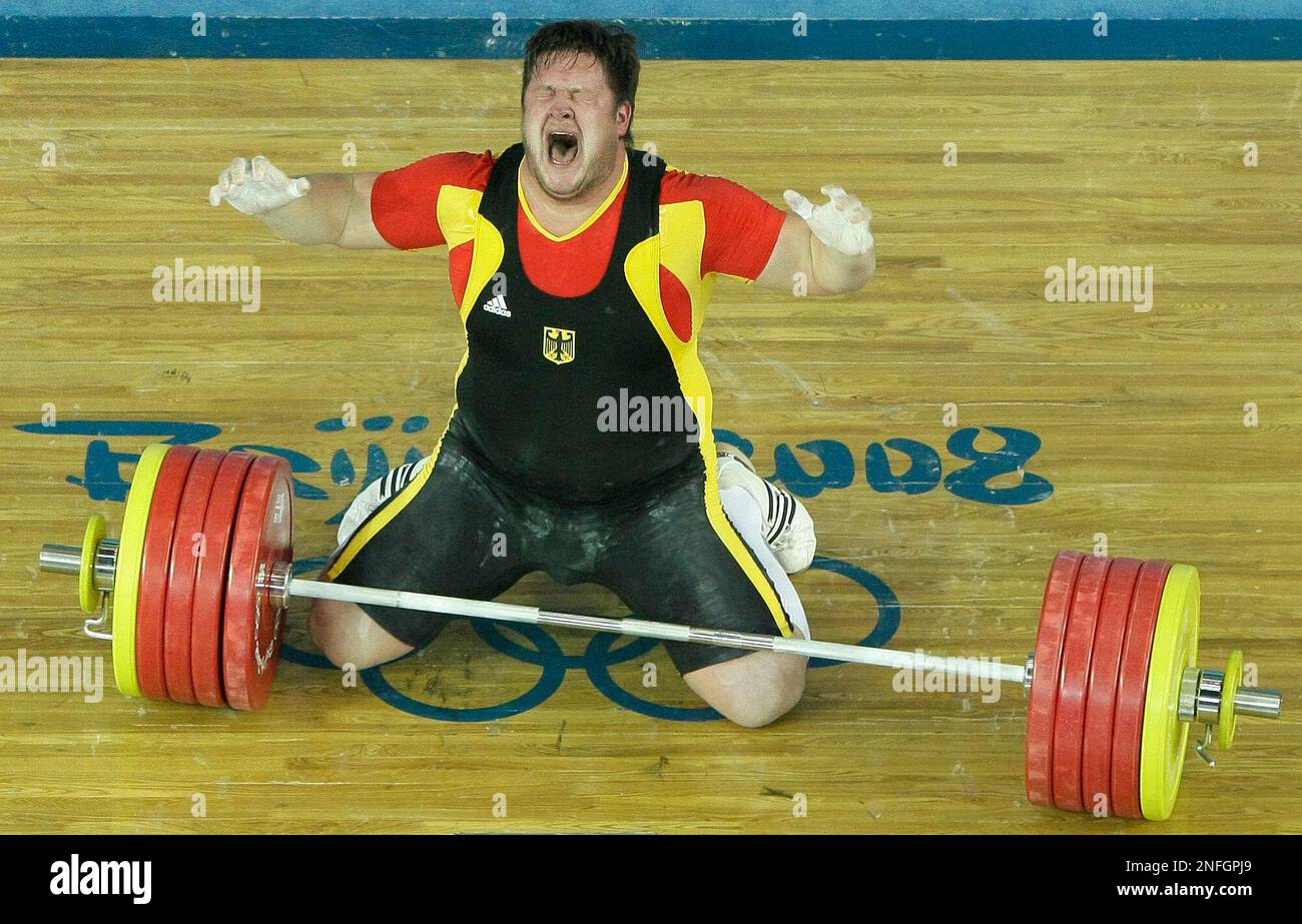 Gold medalist, Matthias Steiner of Germany celebrates a successful lift ...