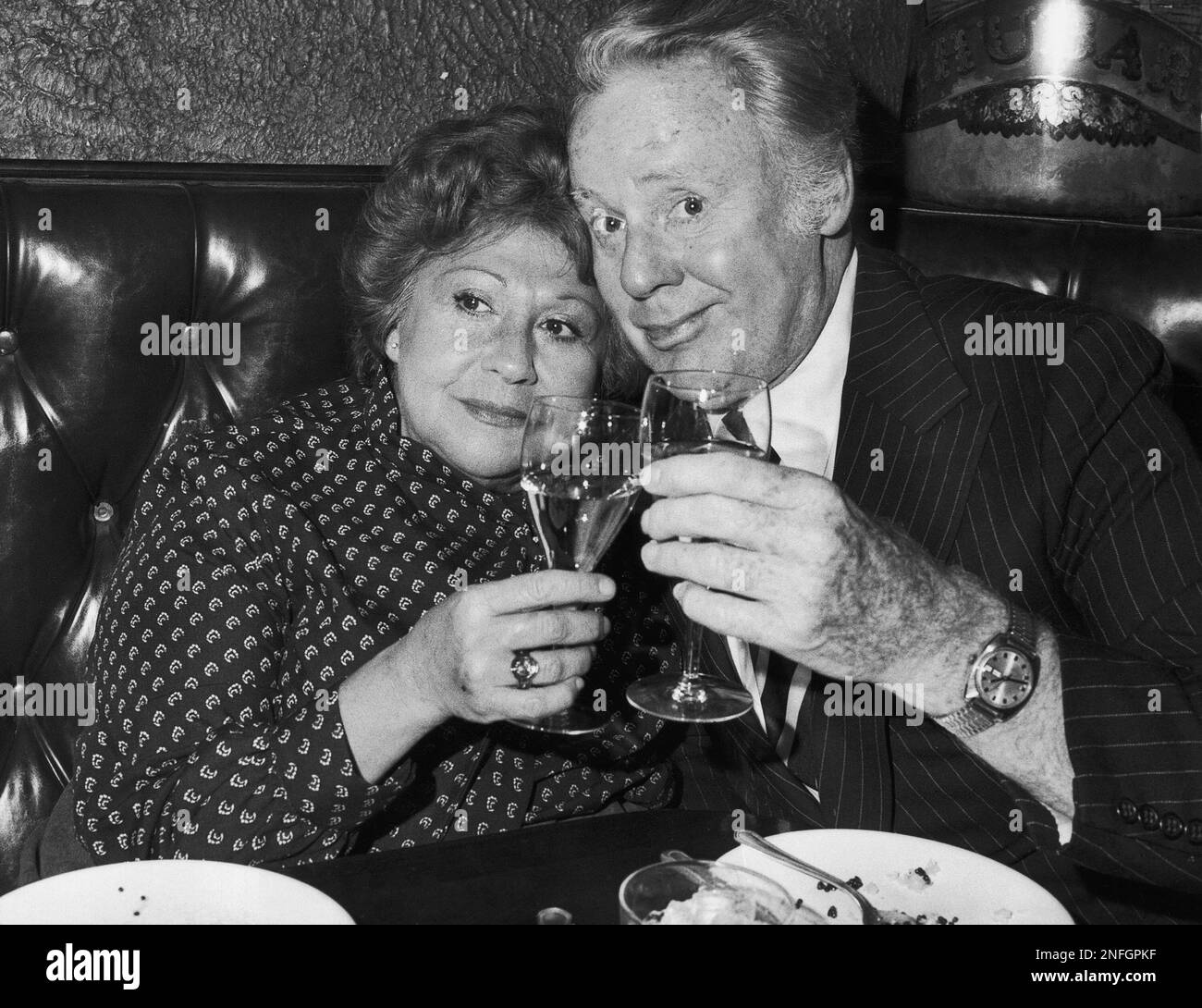 Jazz singer Sylvia Syms and actor Van Johnson toast each other during ...