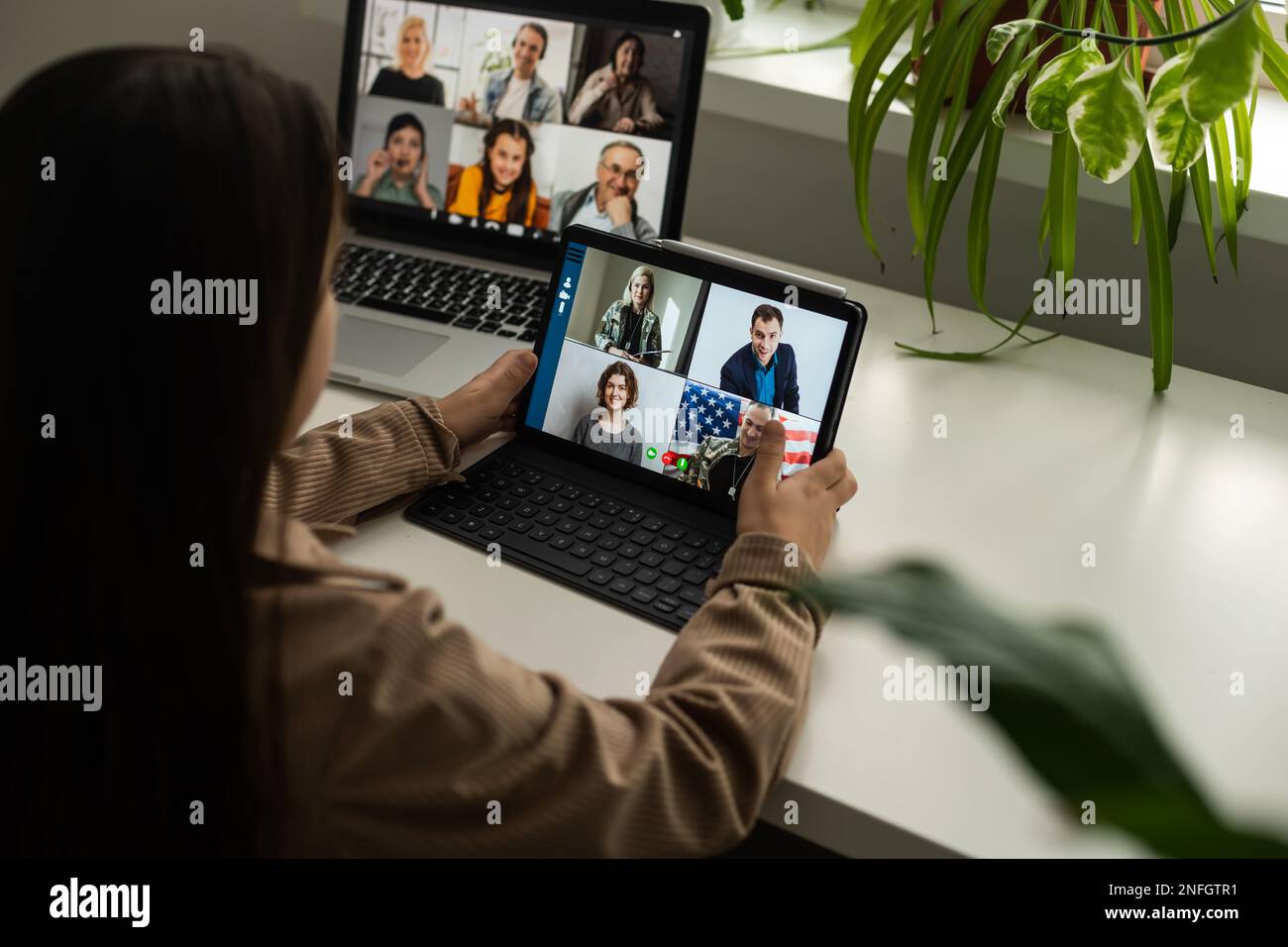 School teen girl student wears headphones distance learning with online ...