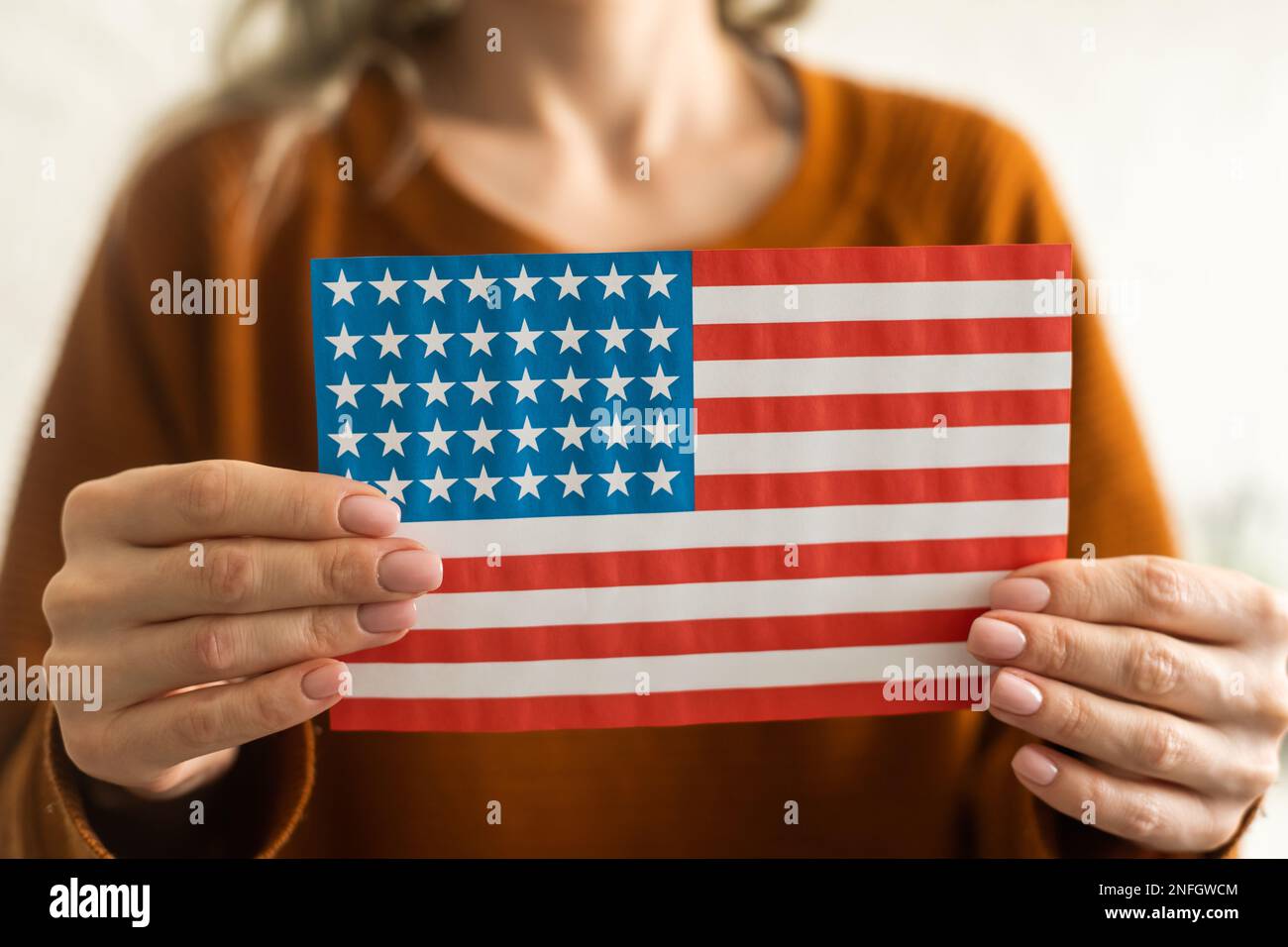 Hand holding american flag on white Stock Photo - Alamy