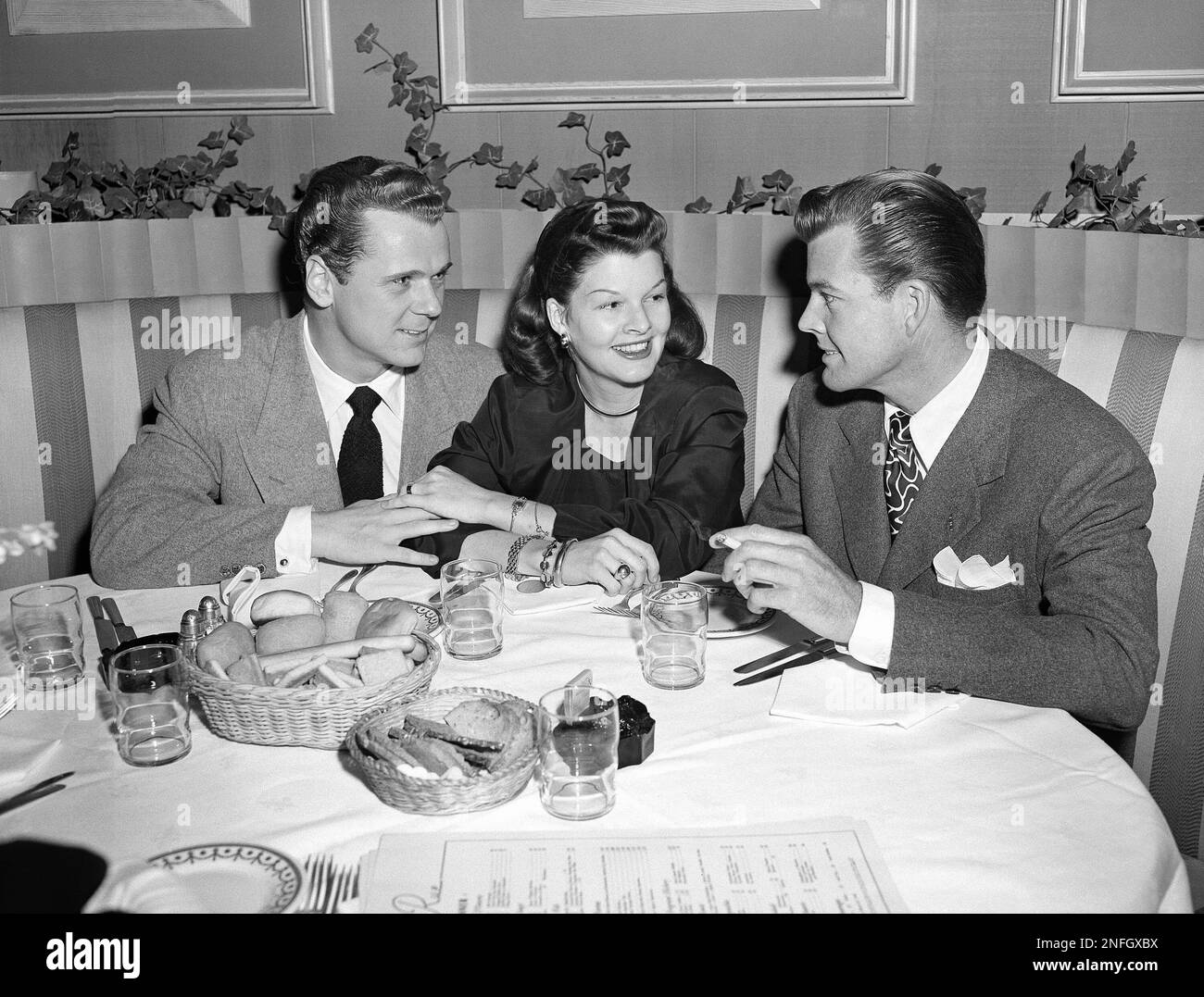 Jackie Cooper, left, helps his wife, June, and her twin brother, Jim ...