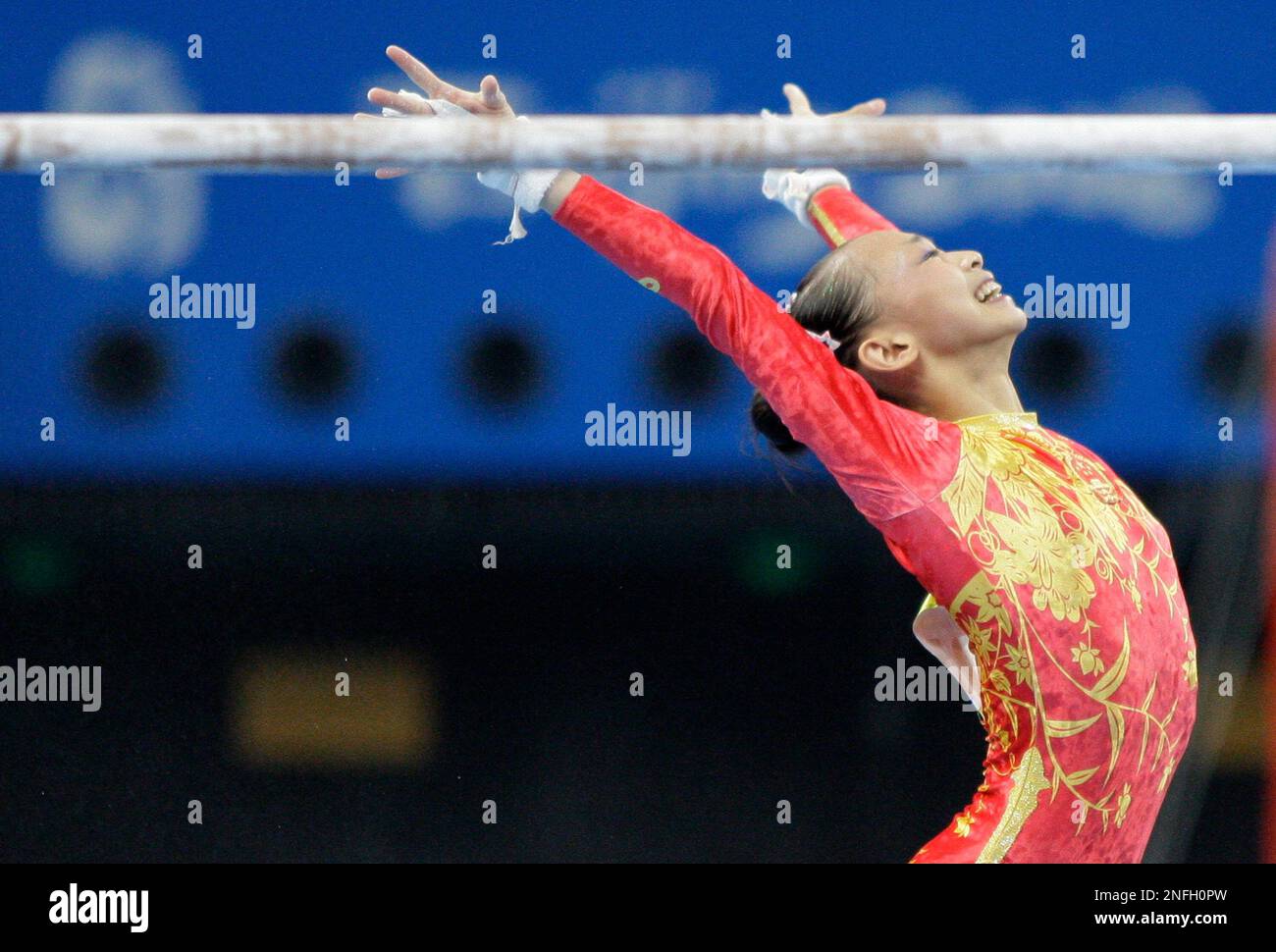China's gymnast Yang Yilin lands after performing on the uneven bars ...