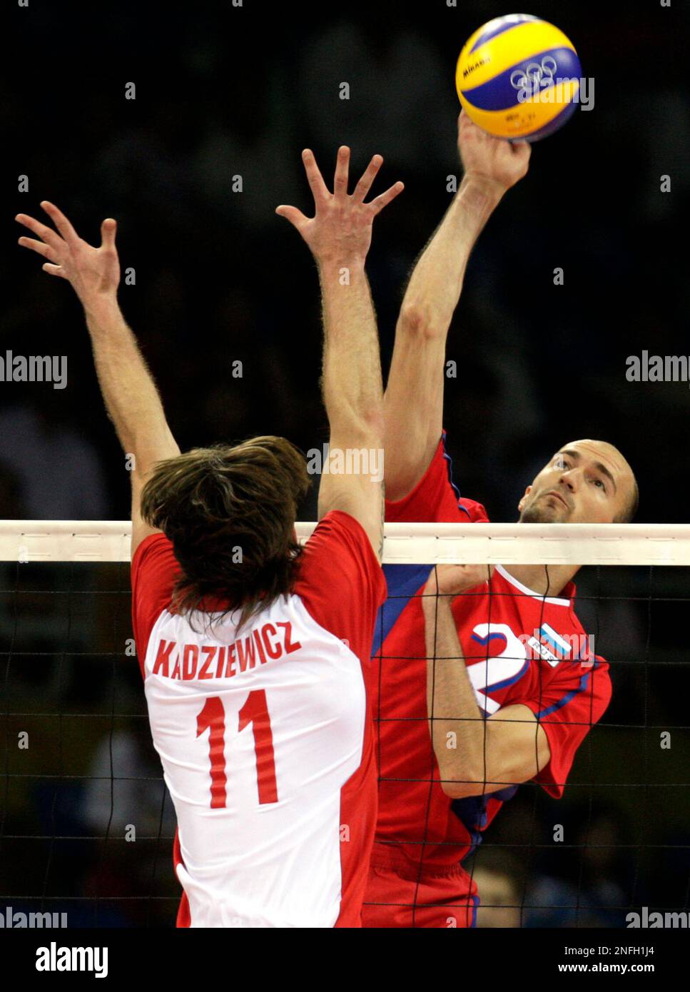 Poland's Lukasz Kadziewicz (11) try to block the shot from Piotr ...