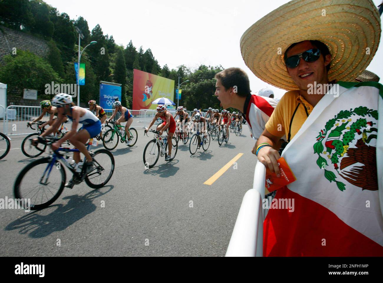 Mexican fans cheer competitors as they cycle during the women's ...