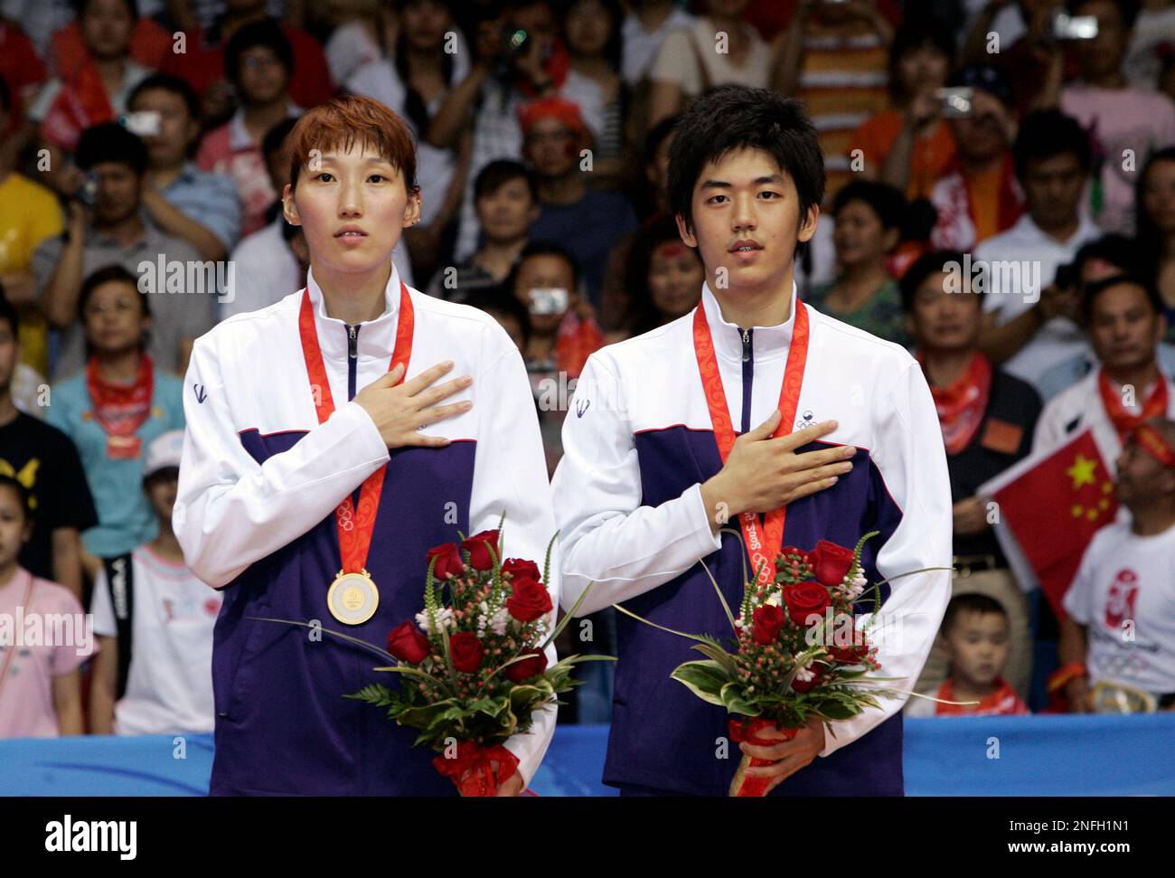 Gold medalists South Korea's Lee Hyo-jung, left, and Lee Yong-dae, during awarding ceremony for ...