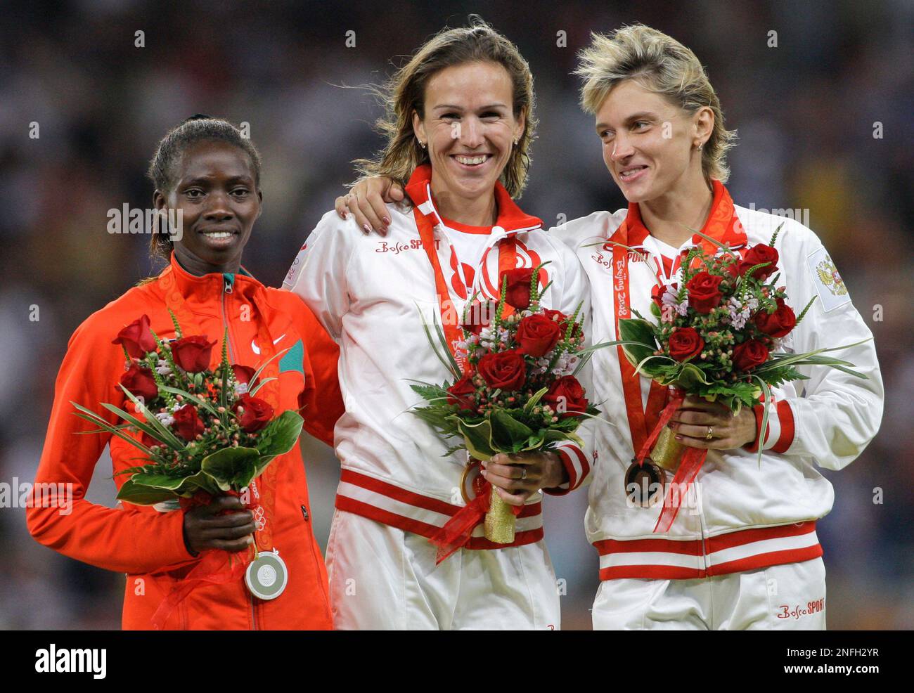 Russia's gold medal winner Gulnara Galkina-Samitova is flanked by ...