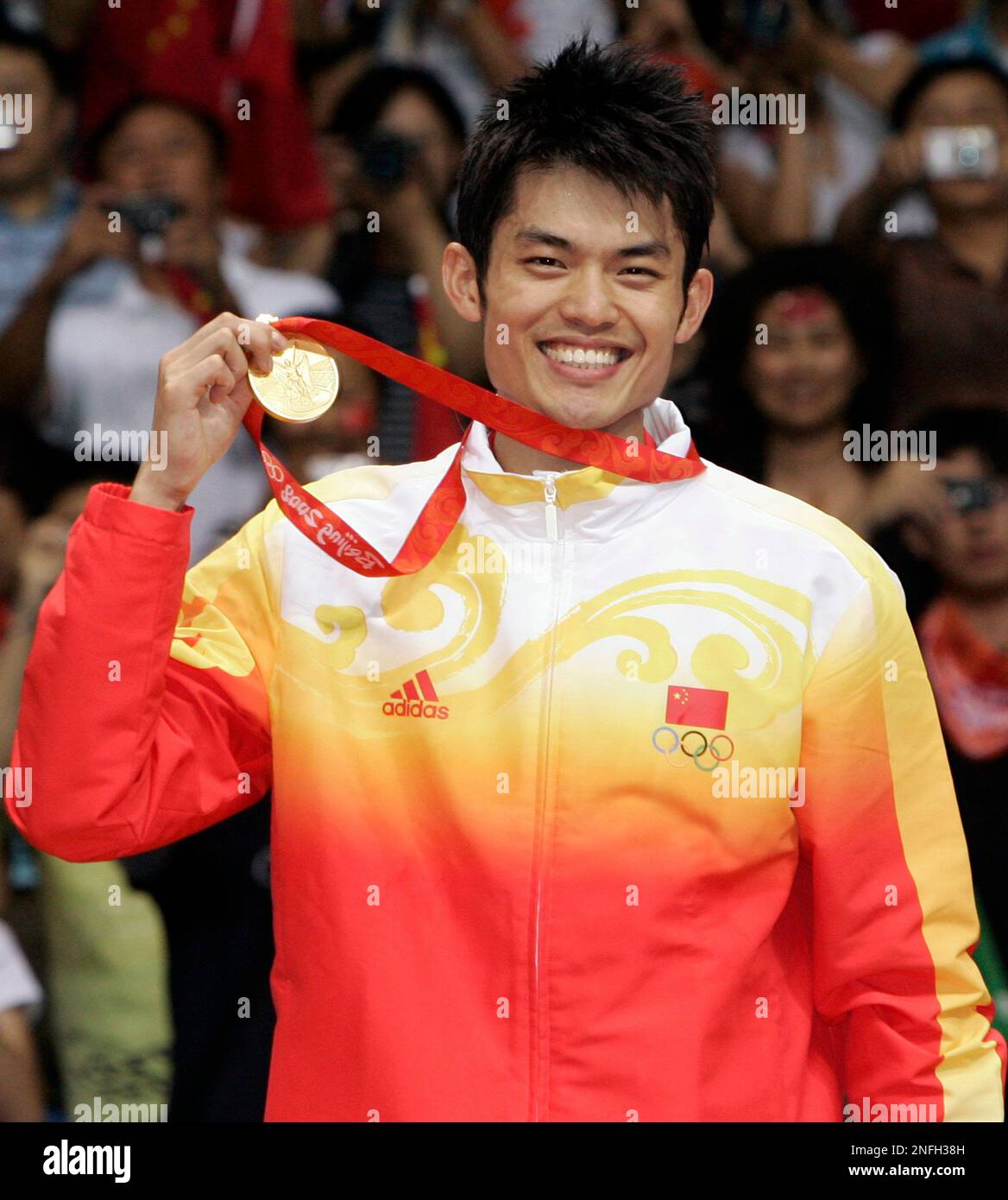 China's Lin Dan displays his gold medal during the awards ceremony for ...