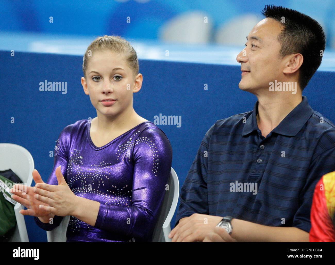 U.S. gymnast Shawn Johnson, left, and coach Liang Chow sit at the side ...