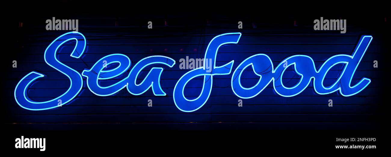 Neon seafood sign against a wall in a seafood restaurant Stock Photo ...