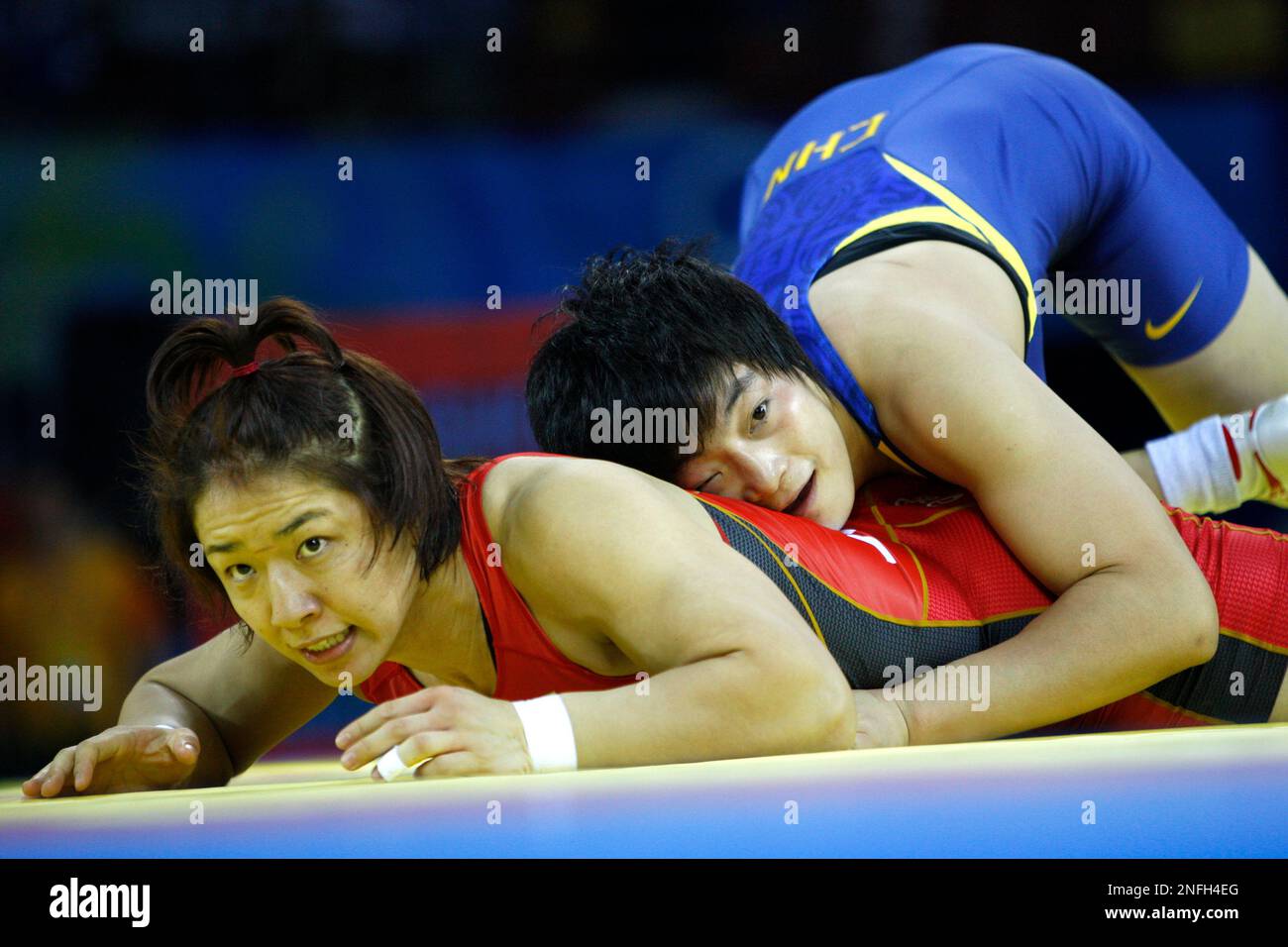 Japan's Kyoko Hamaguchi wearing red wrestles China's Wang Jiao during ...
