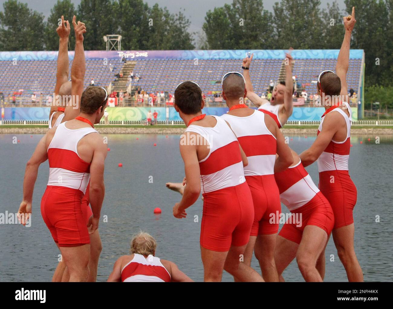 Canada’s coxswain Brian Price is thrown in the water by teammates after ...