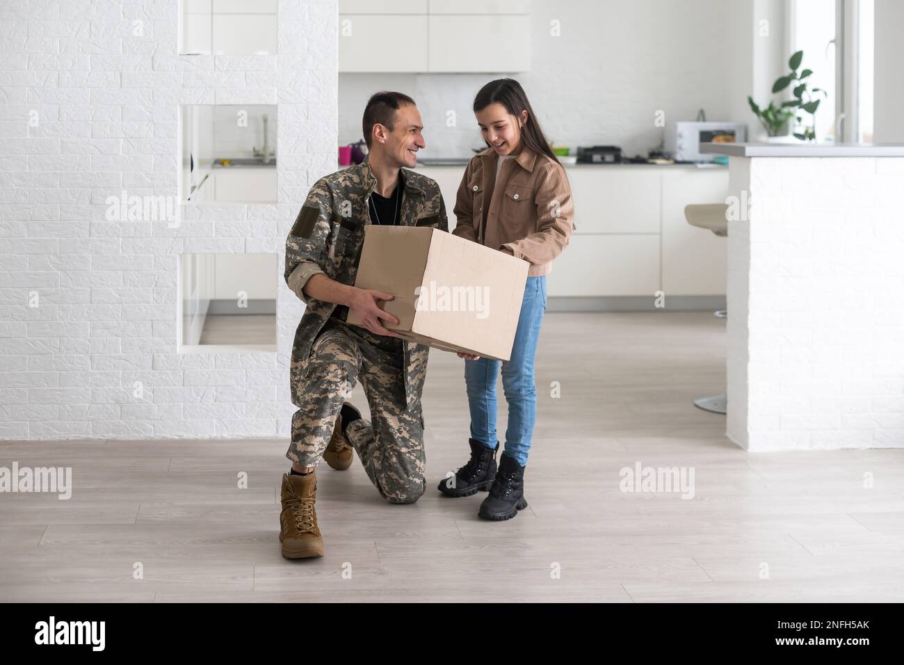 Happy military serviceman holding cardboard box with girl Stock Photo ...