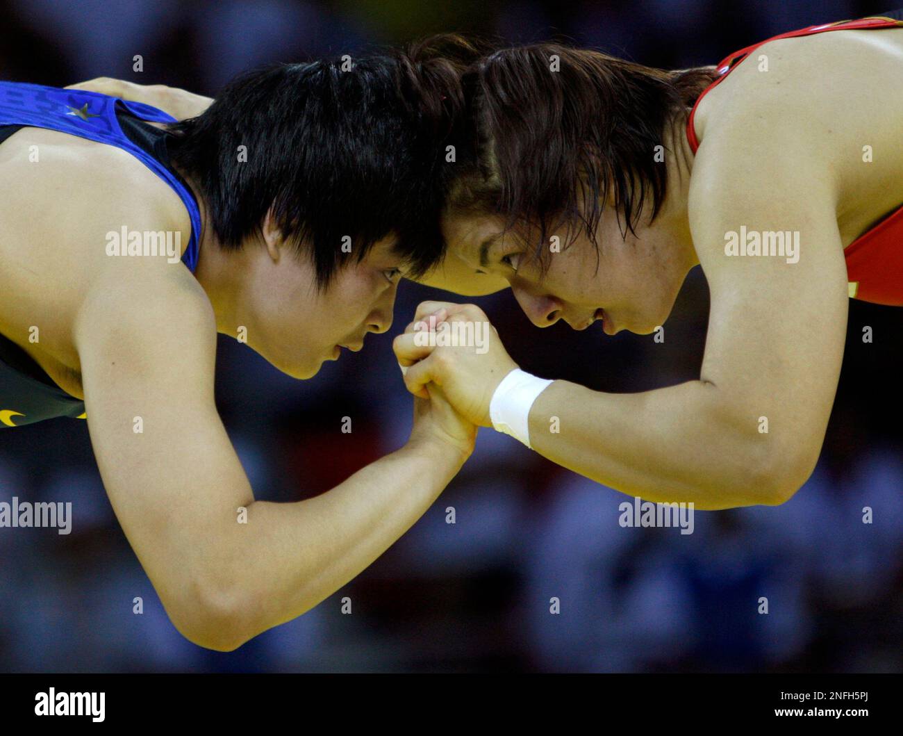 Japan's Kyoko Hamaguchi, in red, wrestles China's Wang Jiao during ...