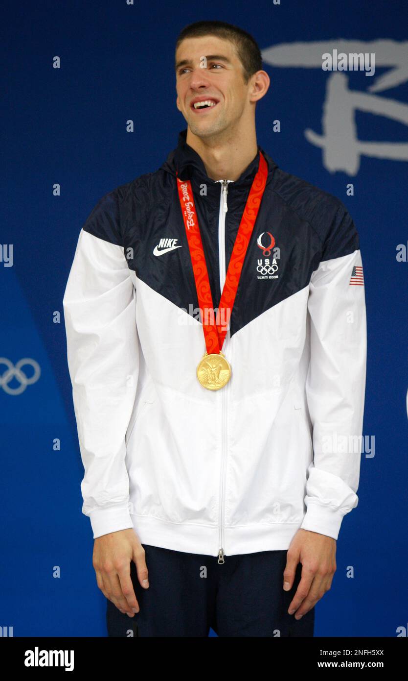 The United States' Michael Phelps reacts on the podium after receiving ...