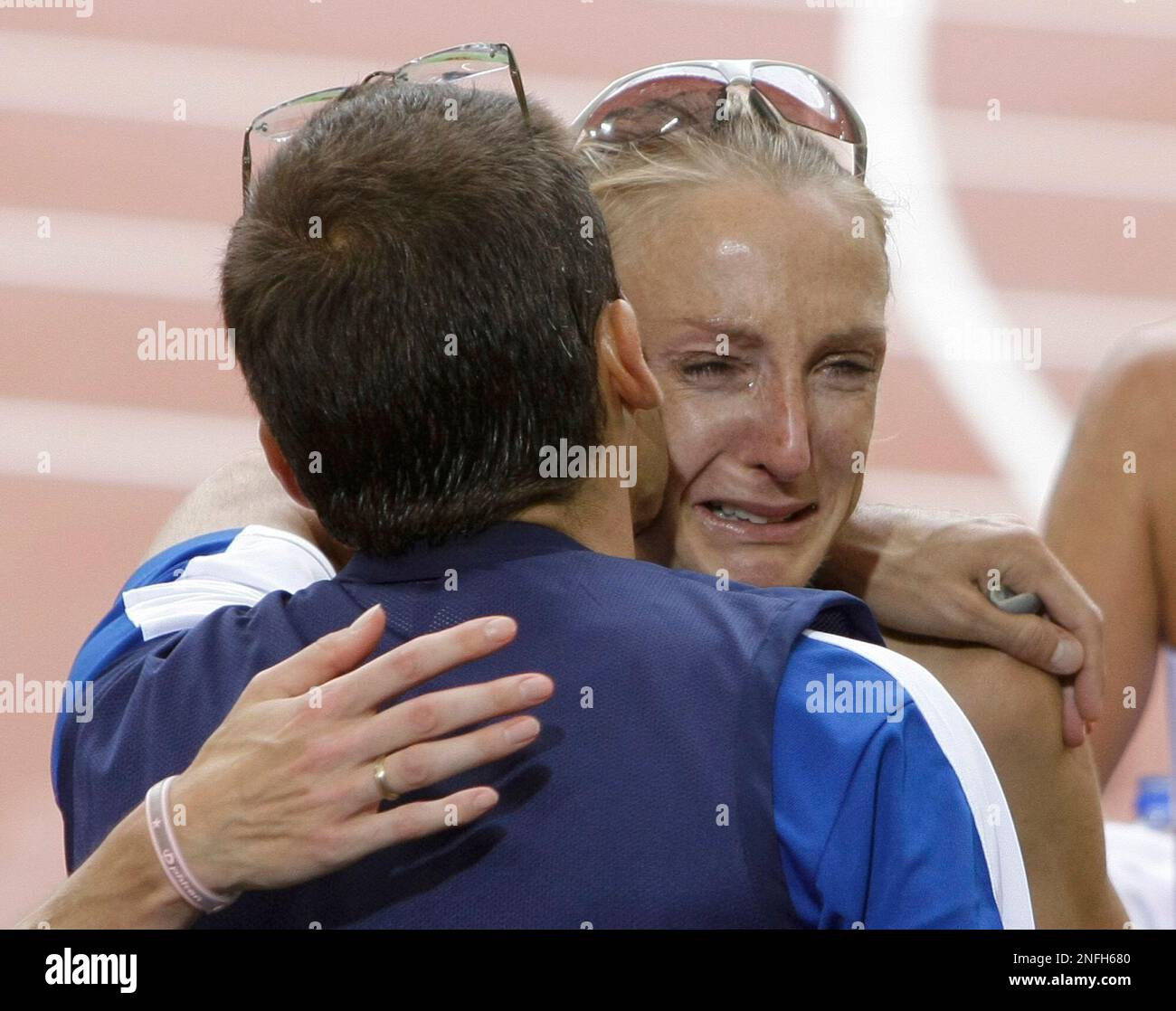 Paula Radcliffe of Britain is hugged by her husband Gary Lough after ...
