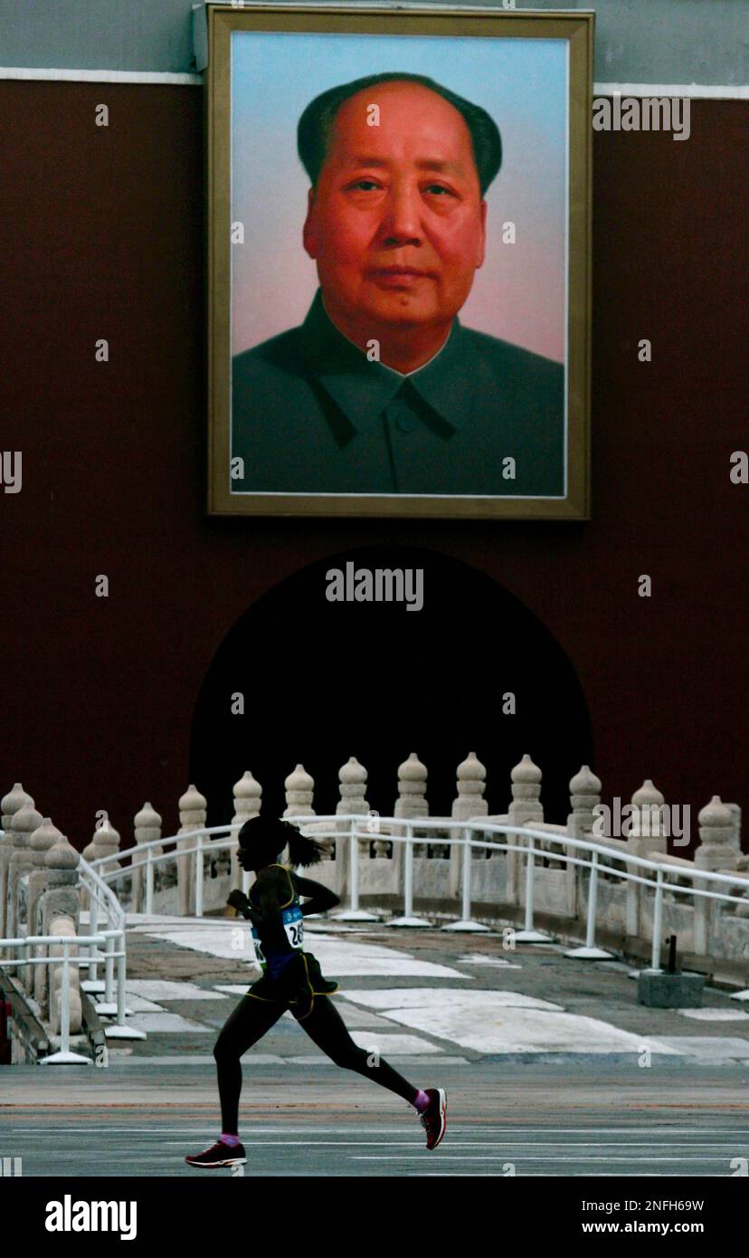 An Olympic woman athlete taking part in the Women's Marathon runs past ...