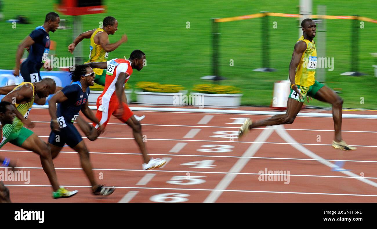 Jamaica's Usain Bolt, right, crosses the finish line to win gold in the ...