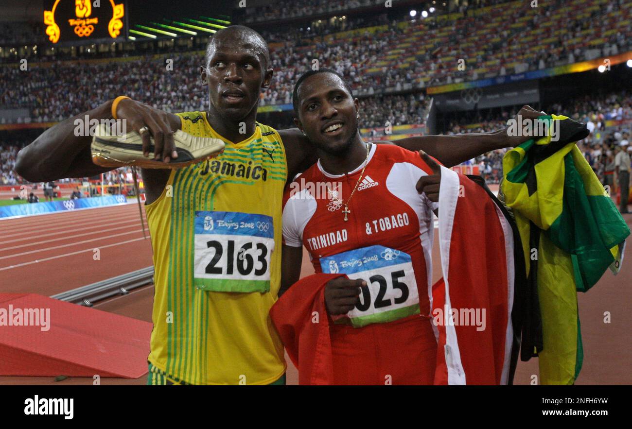 Olympic 100m champion Usain Bolt of Jamaica, left, poses with runner up ...